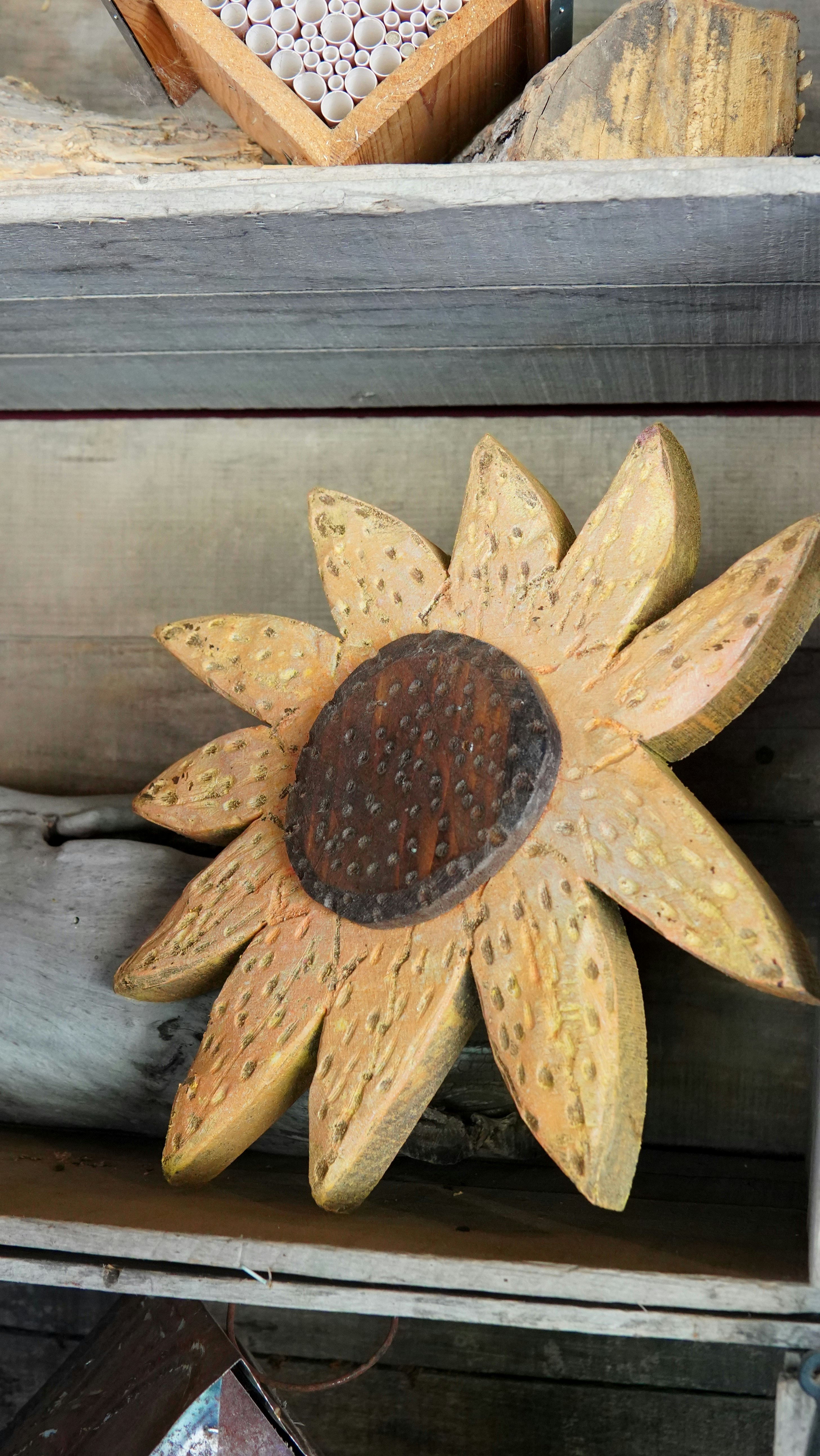 Rustic Wood Sunflower: A Carved Bloom Resting in a Workshop Nook