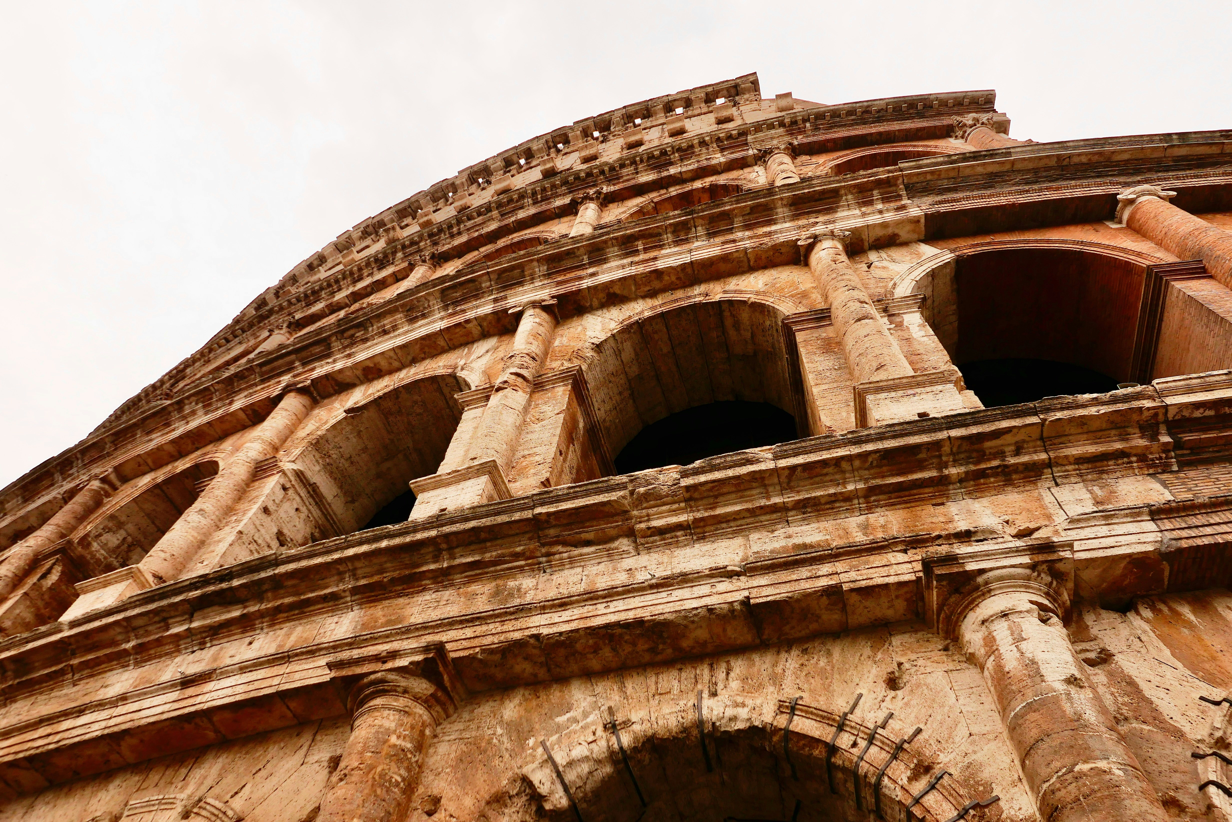 The colosseum in rome against a cloudy sky