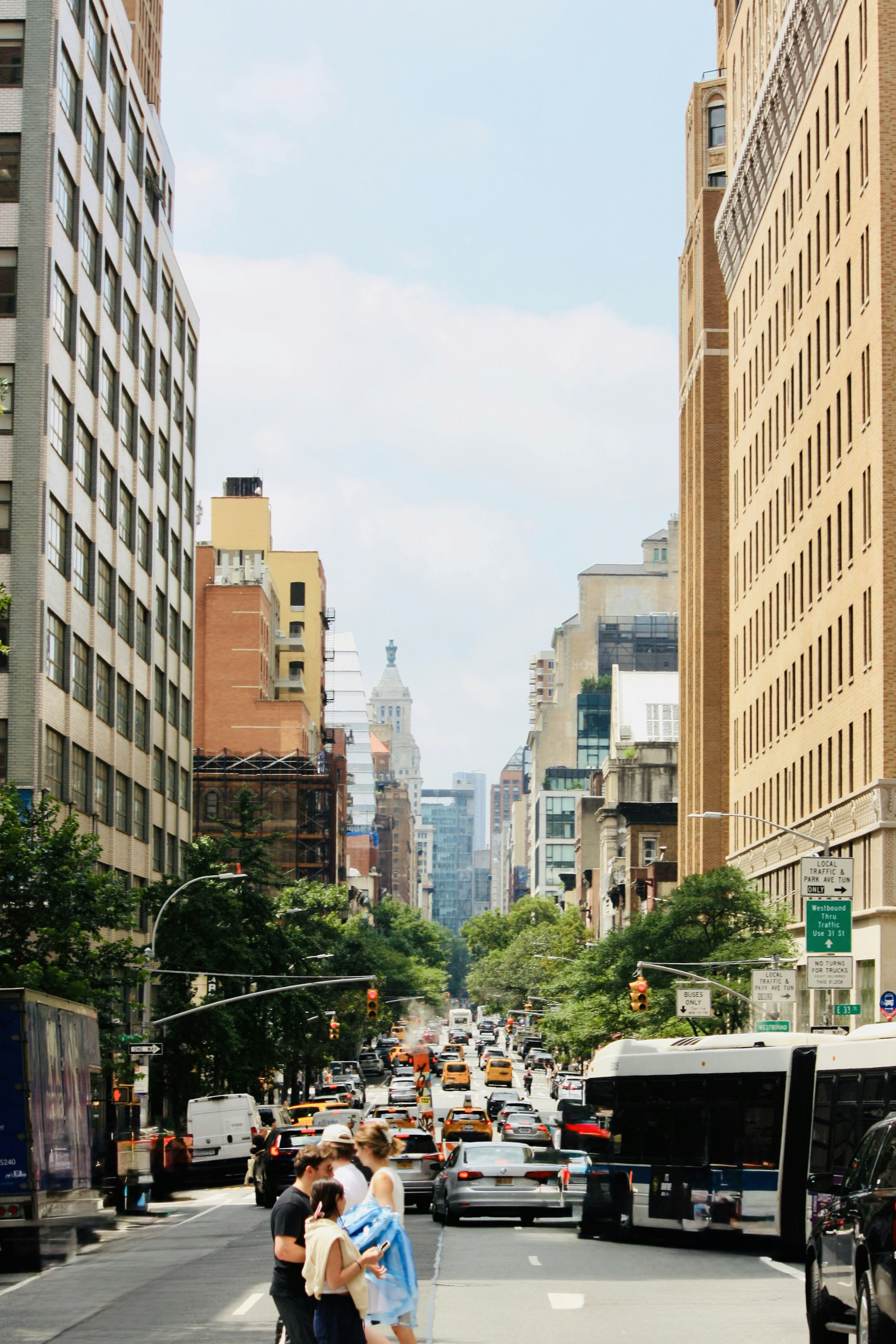 Busy new york city street with traffic and pedestrians.