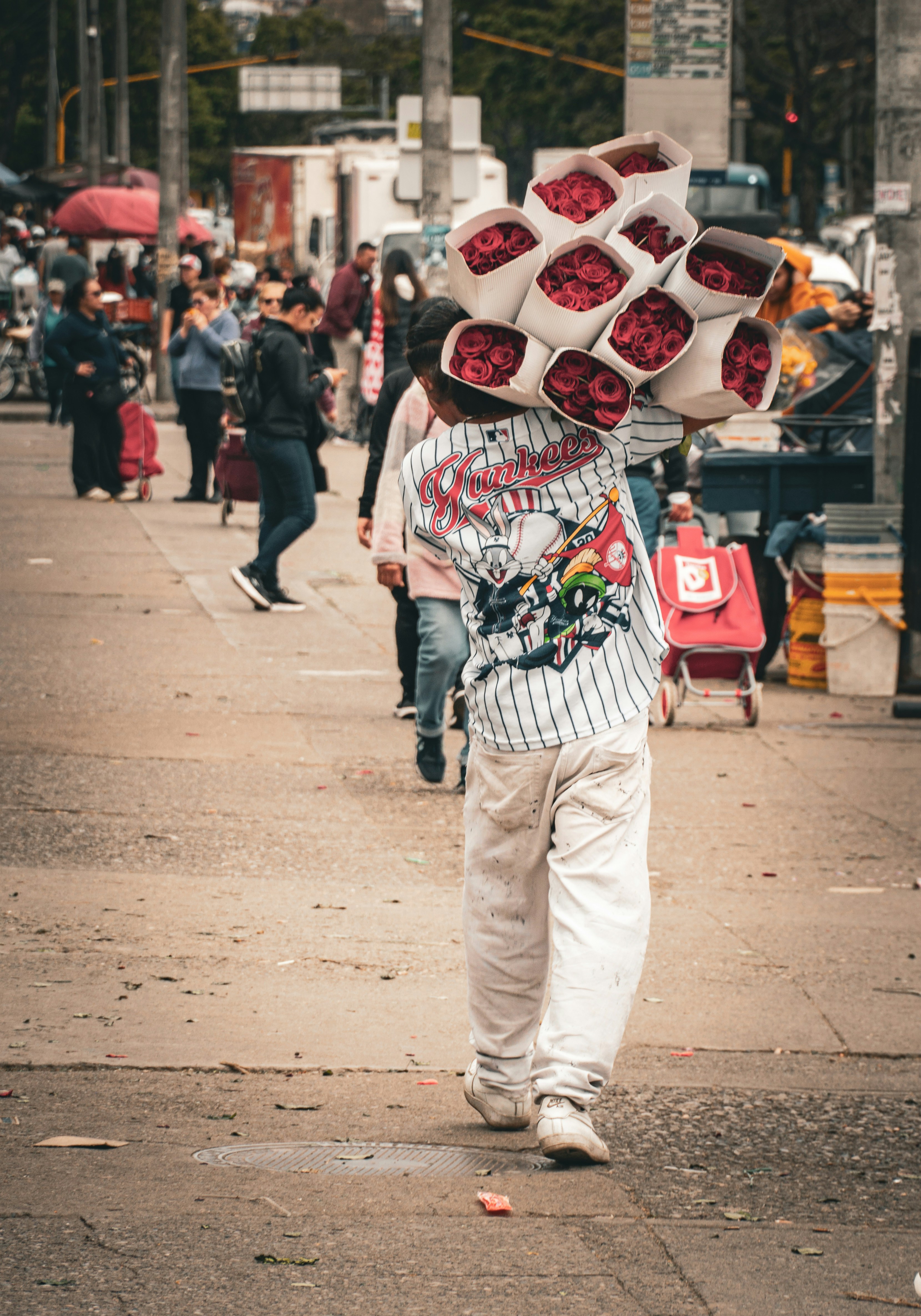 Man carrying a large bouquet of red roses on shoulder photo – Free ...