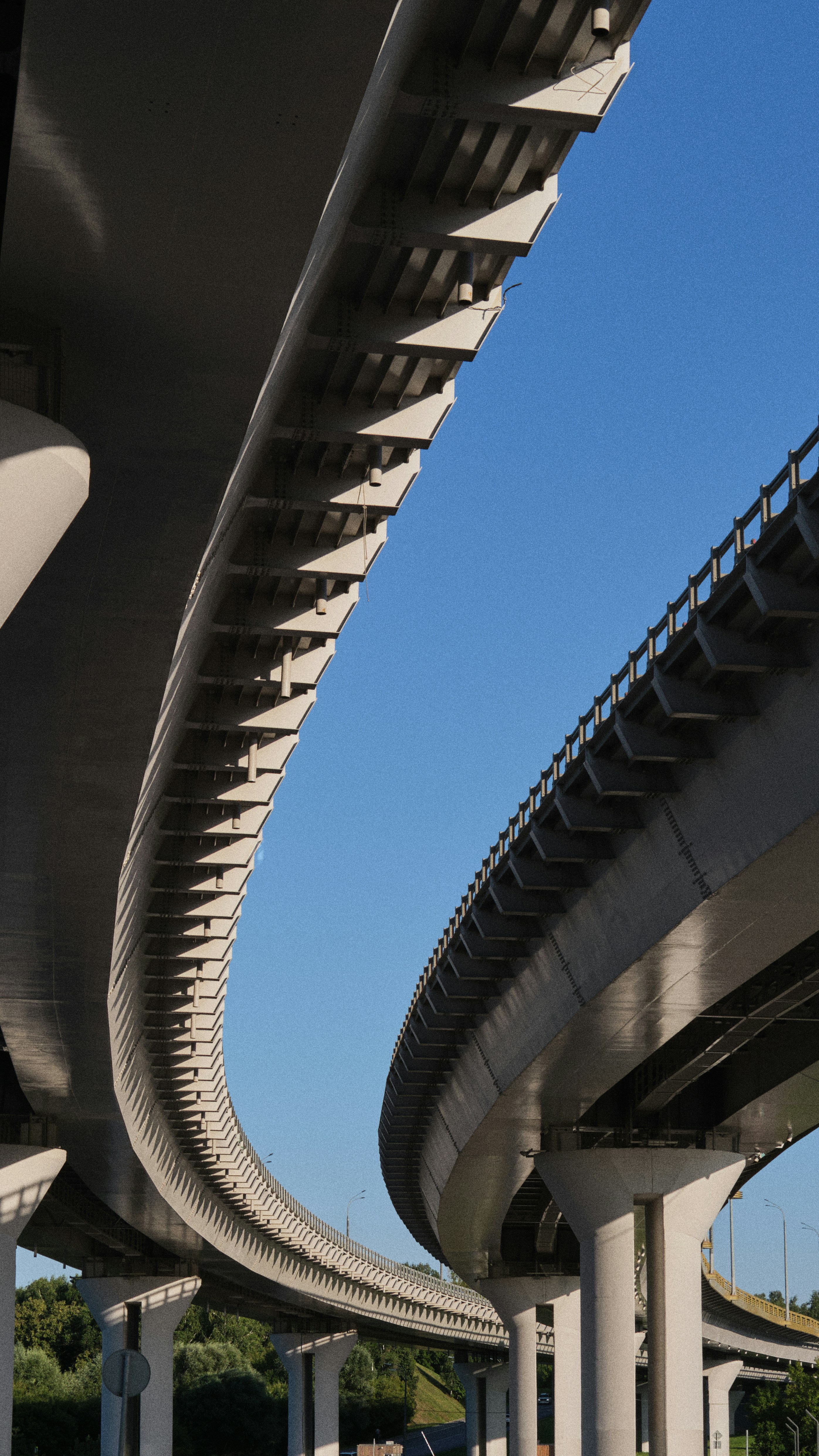 Curving highway overpasses against a clear blue sky