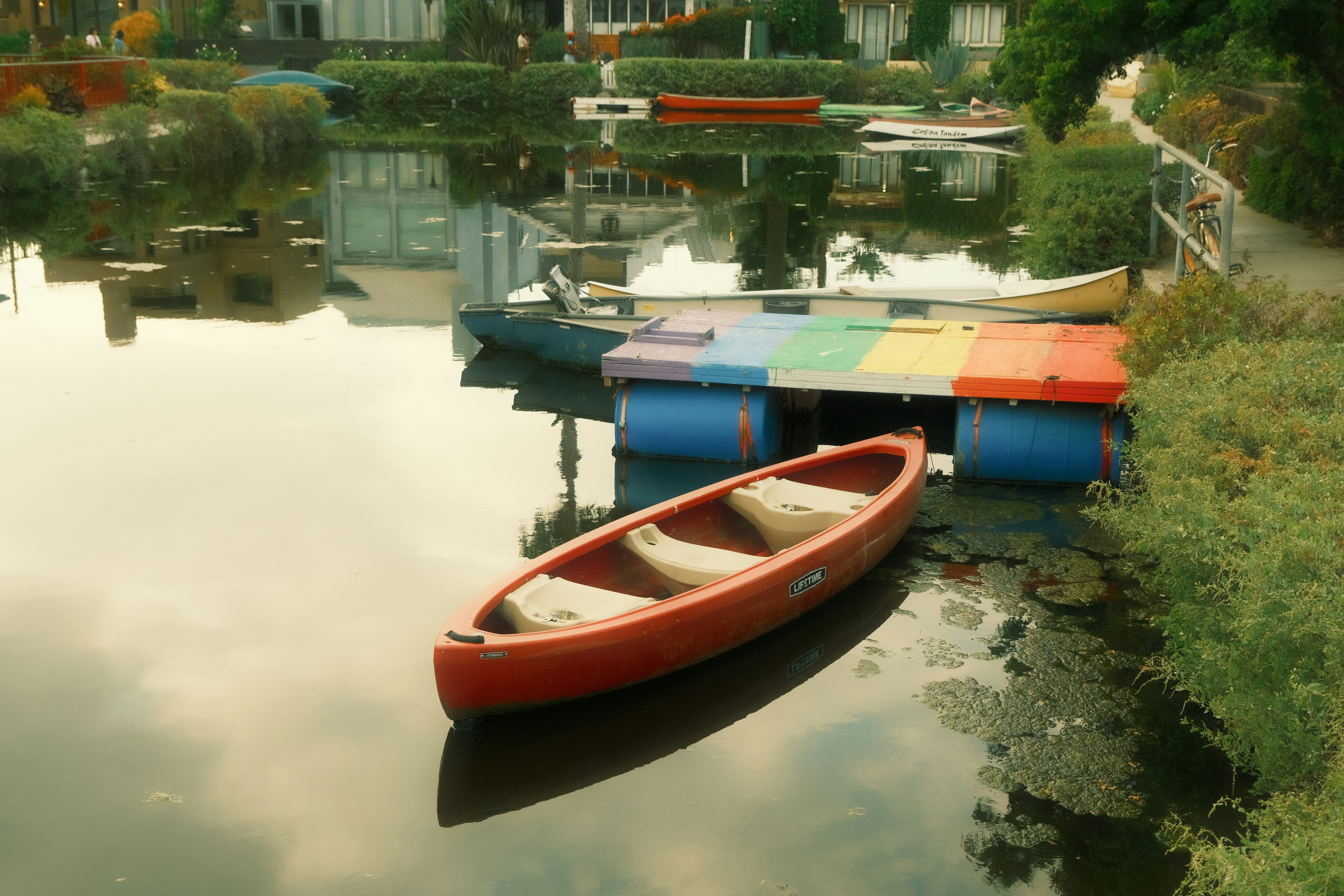 Reflections of Serenity: A Colorful Canoe Scene
