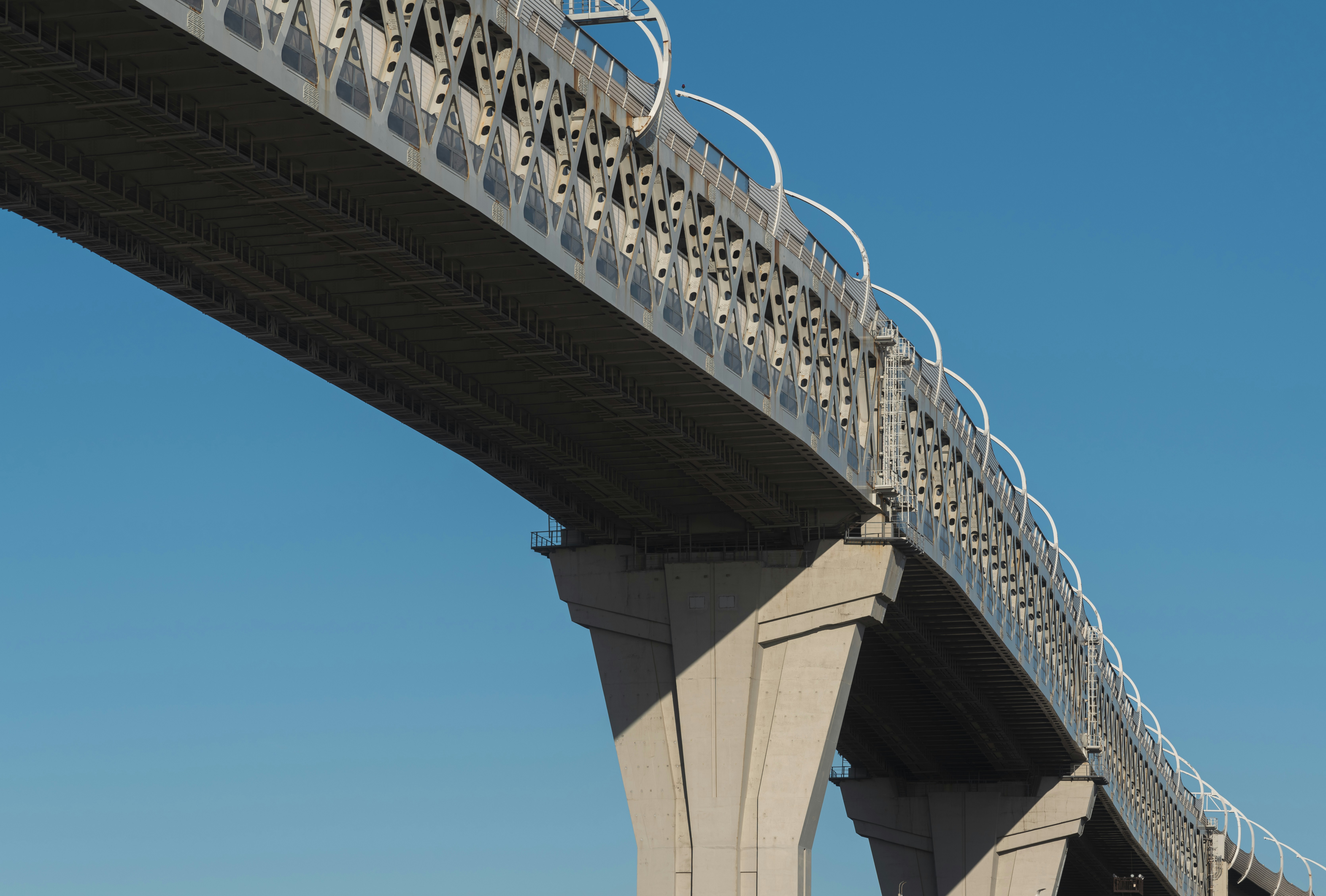 Modern bridge structure against a clear blue sky