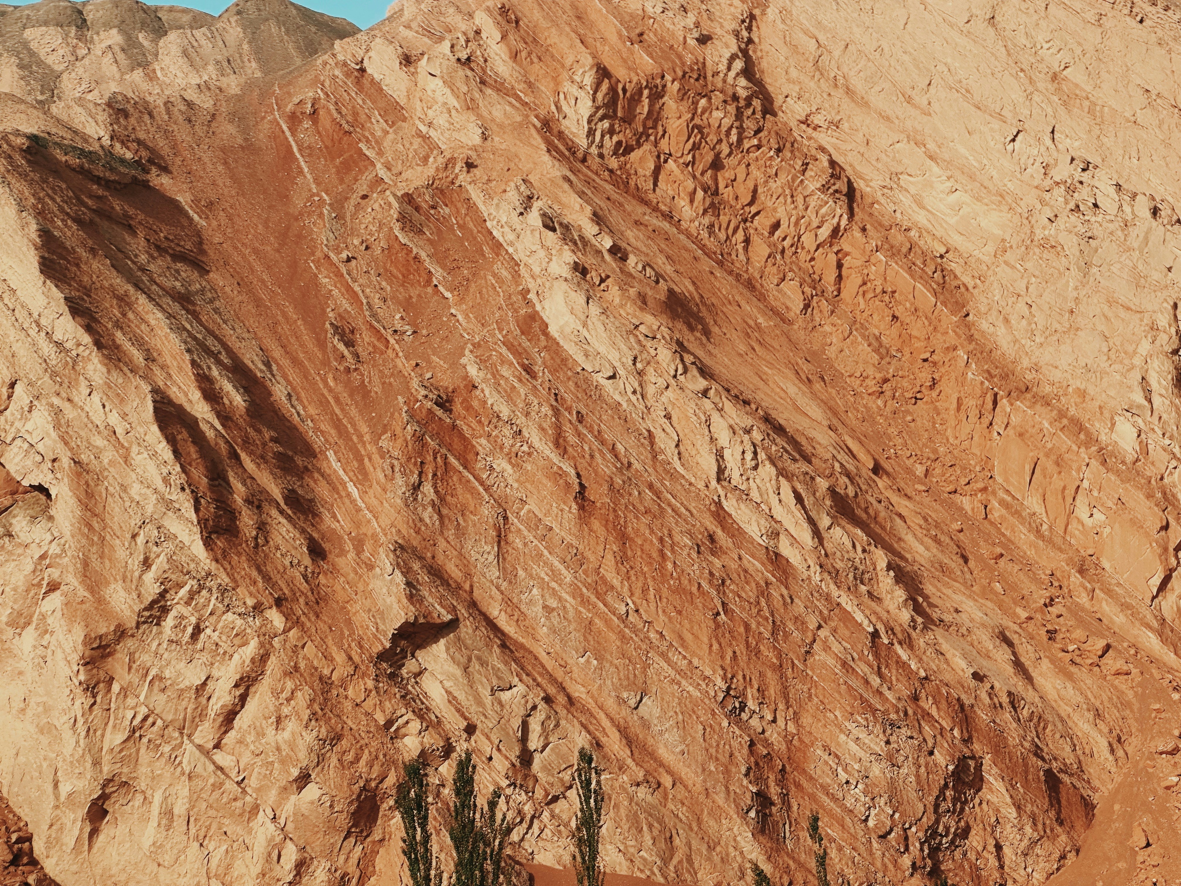 Ember-Layered Bluff: Sunlit Sedimentary Striations