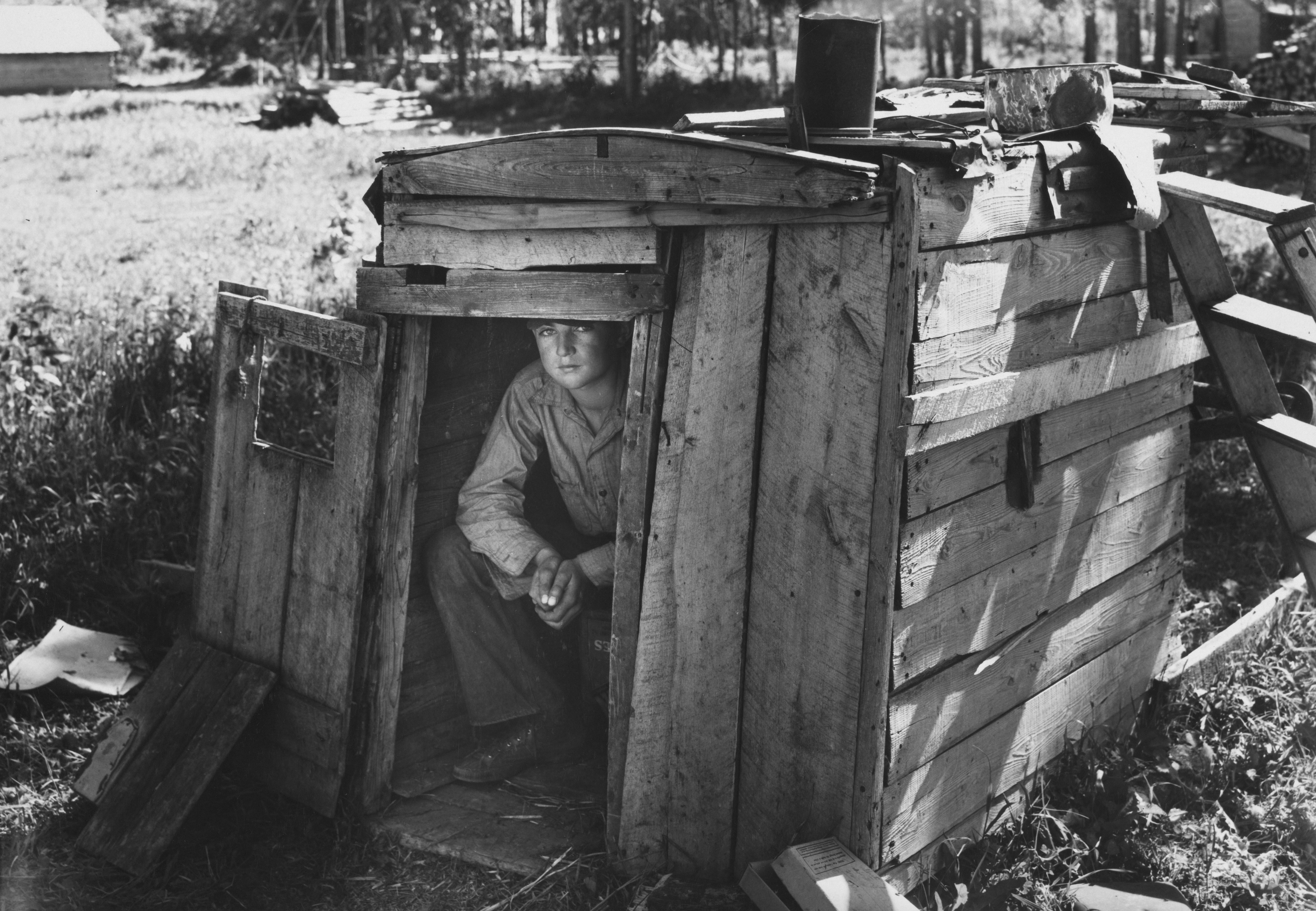 A person peeks out of a rustic wooden shack. photo – Free Child Image ...