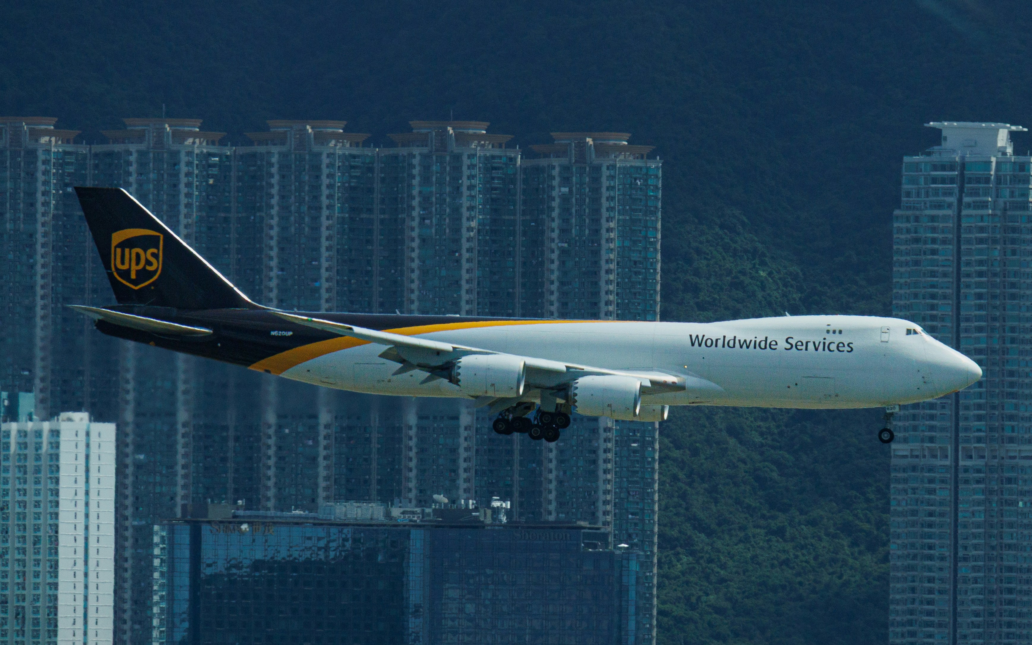 Aerial Delivery: UPS in Flight Over Urban Landscape