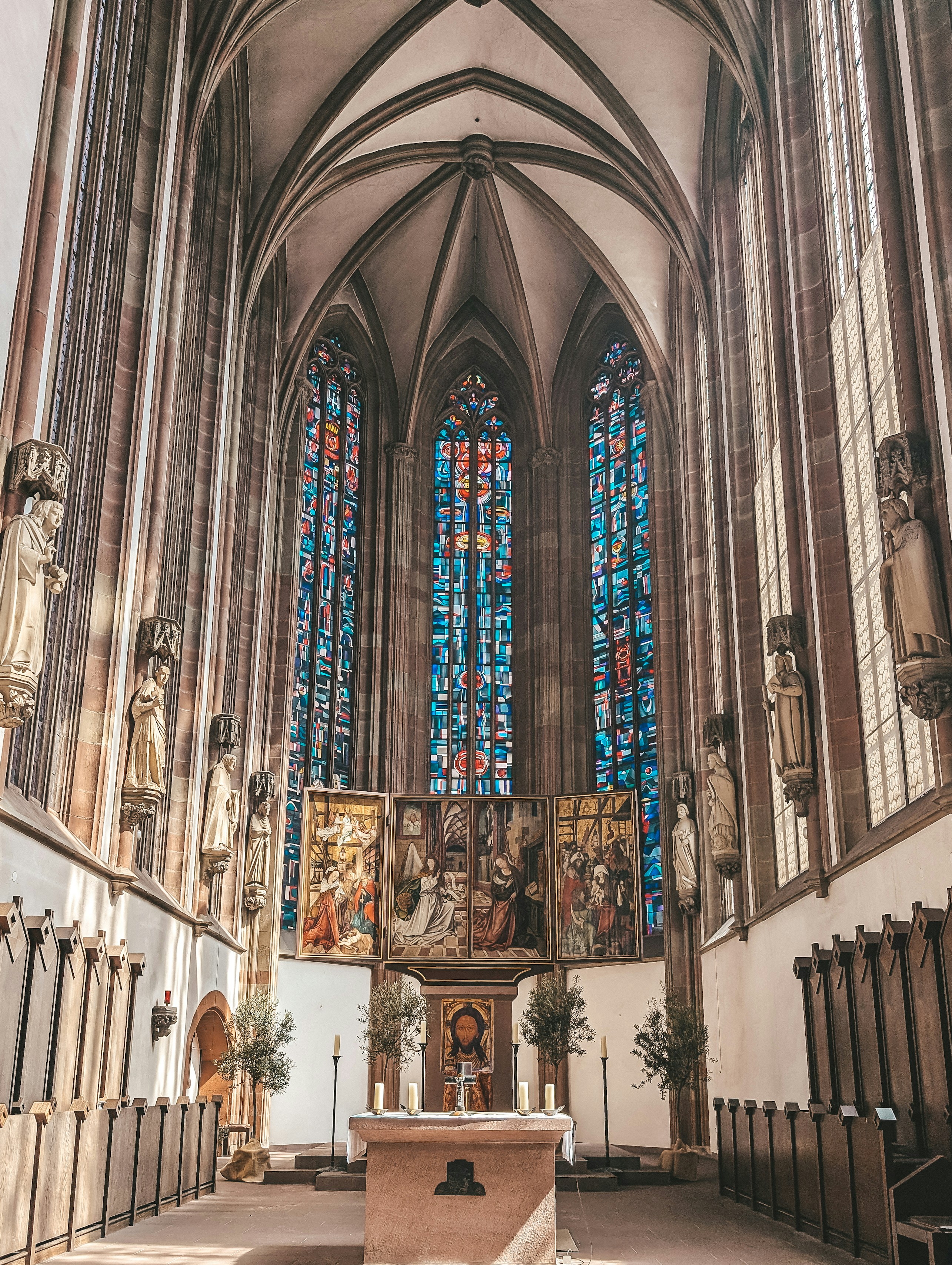 Gothic Choir and Stained Glass | Interior of a grand cathedral with stained glass windows.
