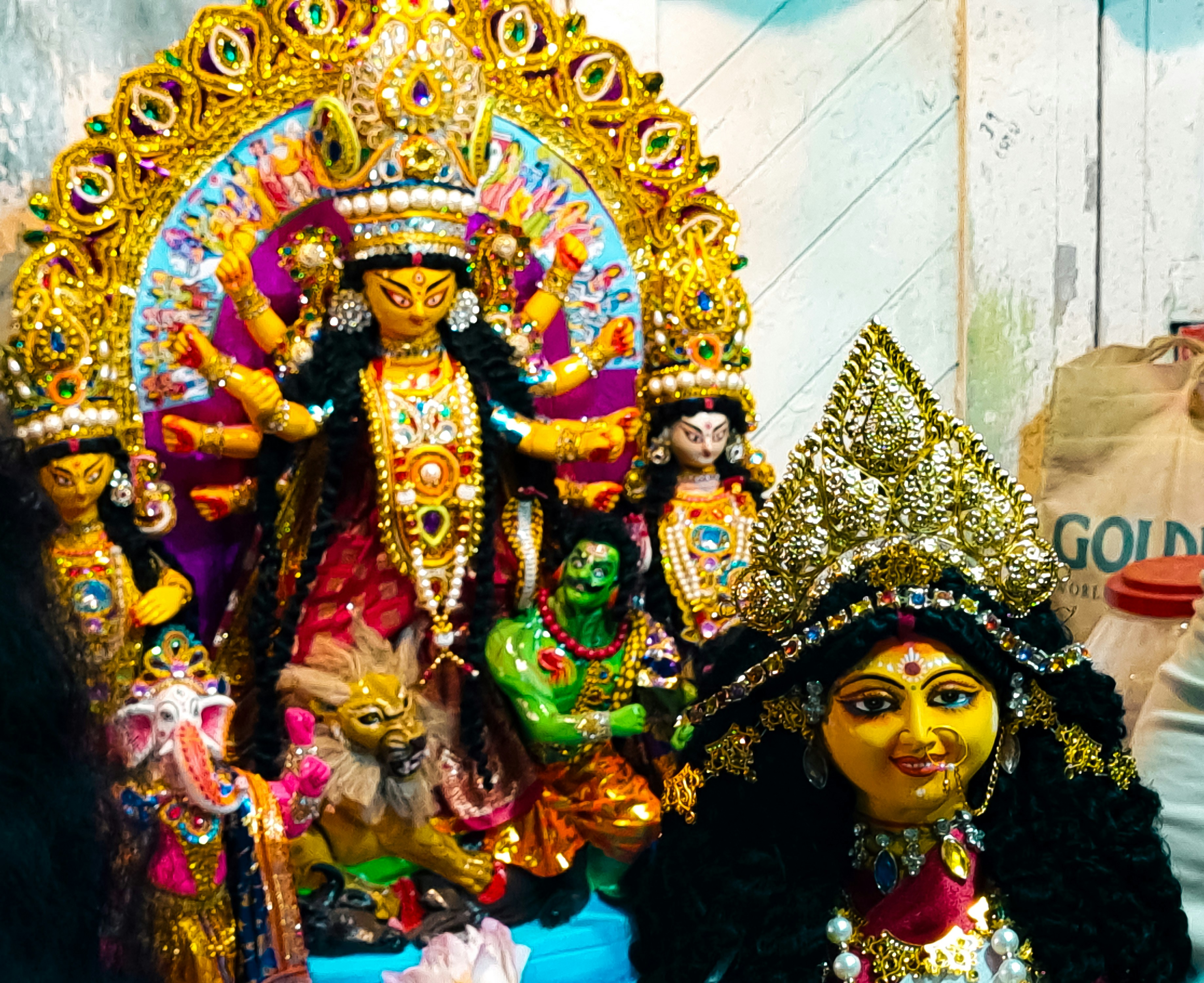 Vibrant idols of deities adorned with intricate decorations, showcasing the rich cultural heritage during a festive celebration.