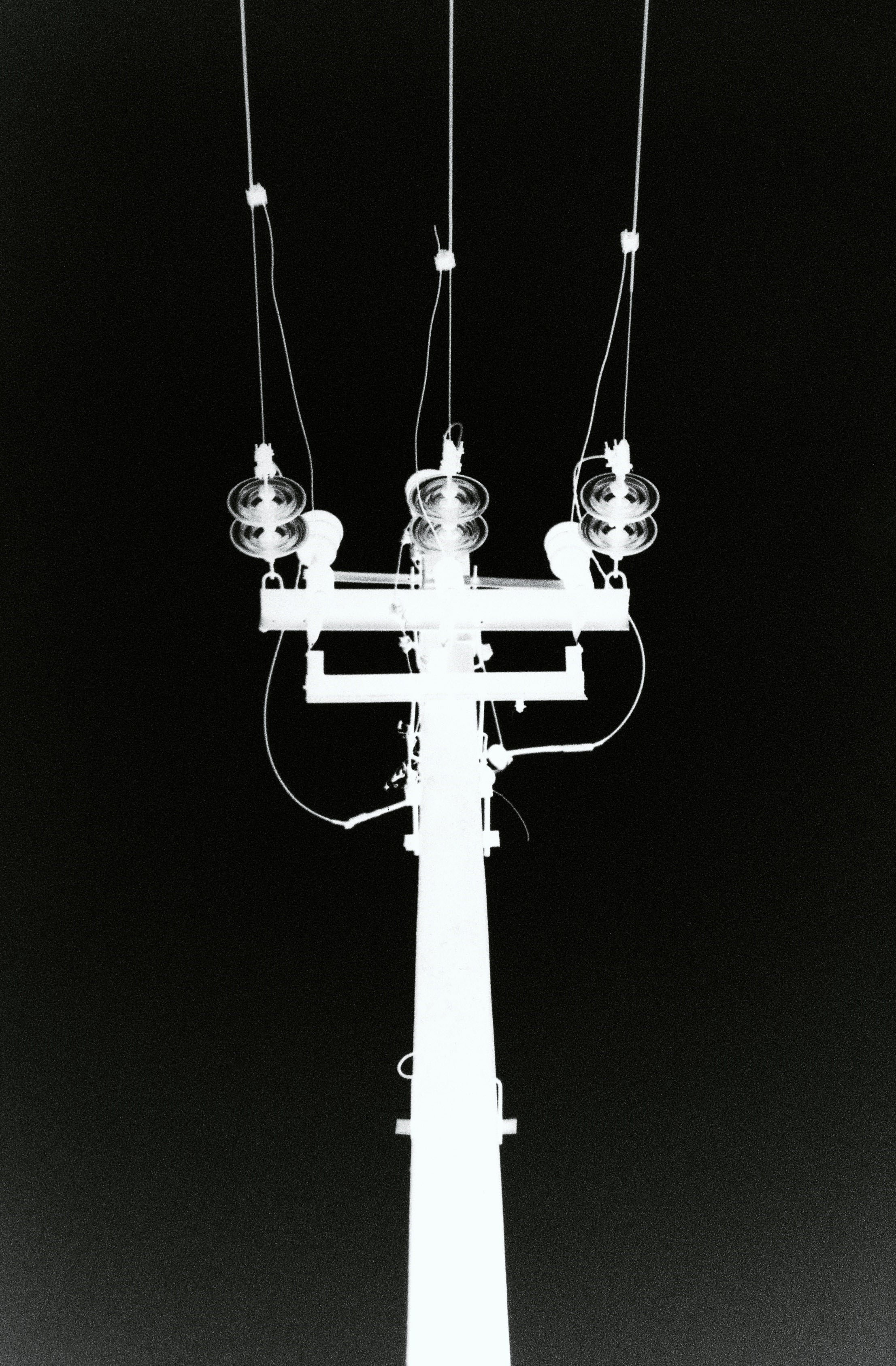 A utility pole against a dark sky