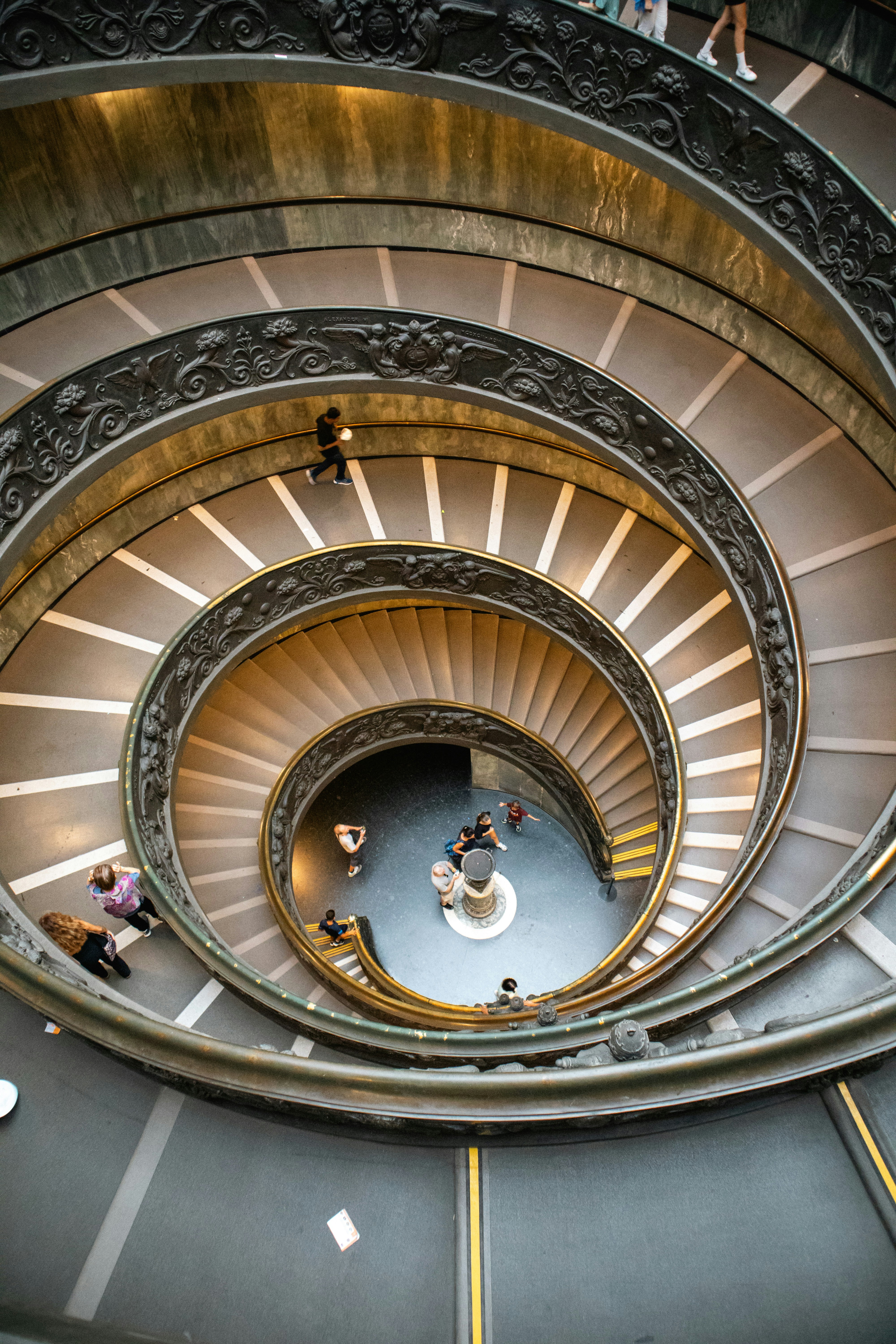 People walking on a grand spiral staircase
