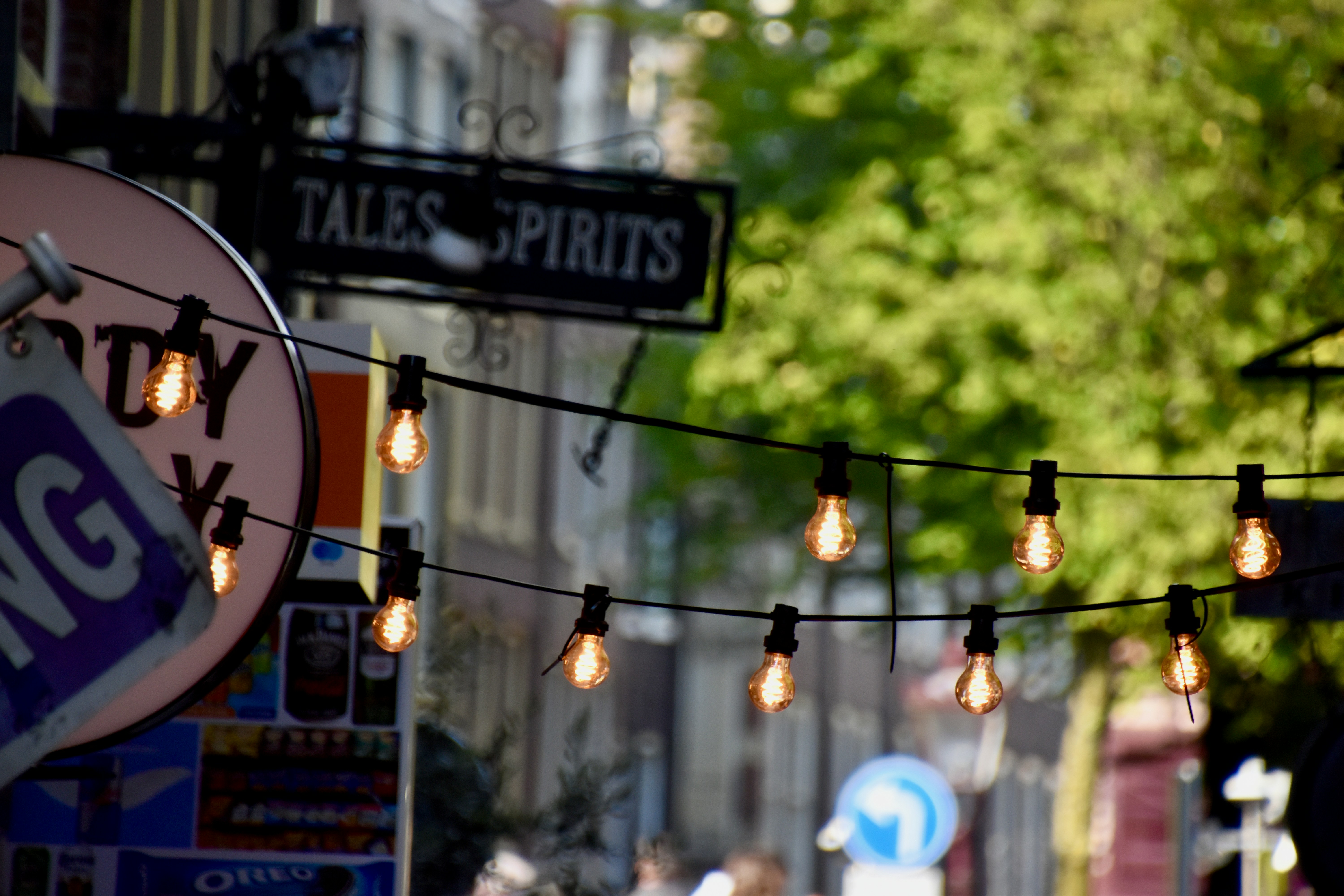 String lights hang above a street sign