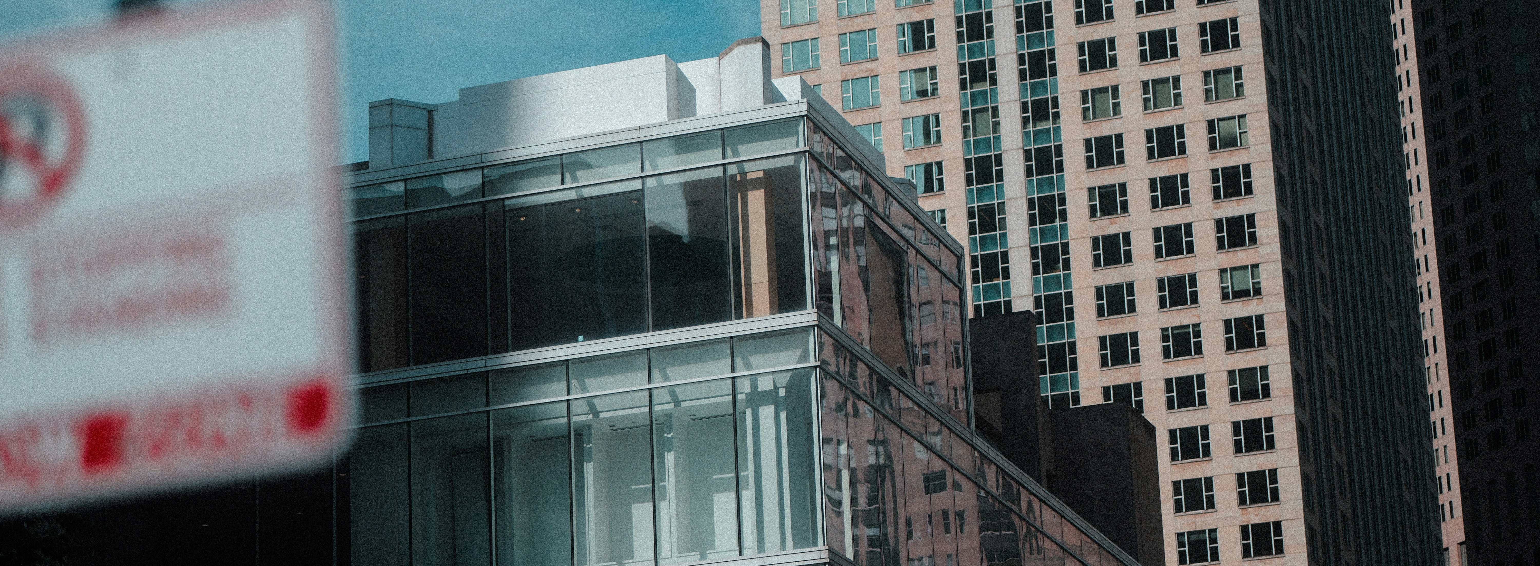 Modern glass building against older brick architecture