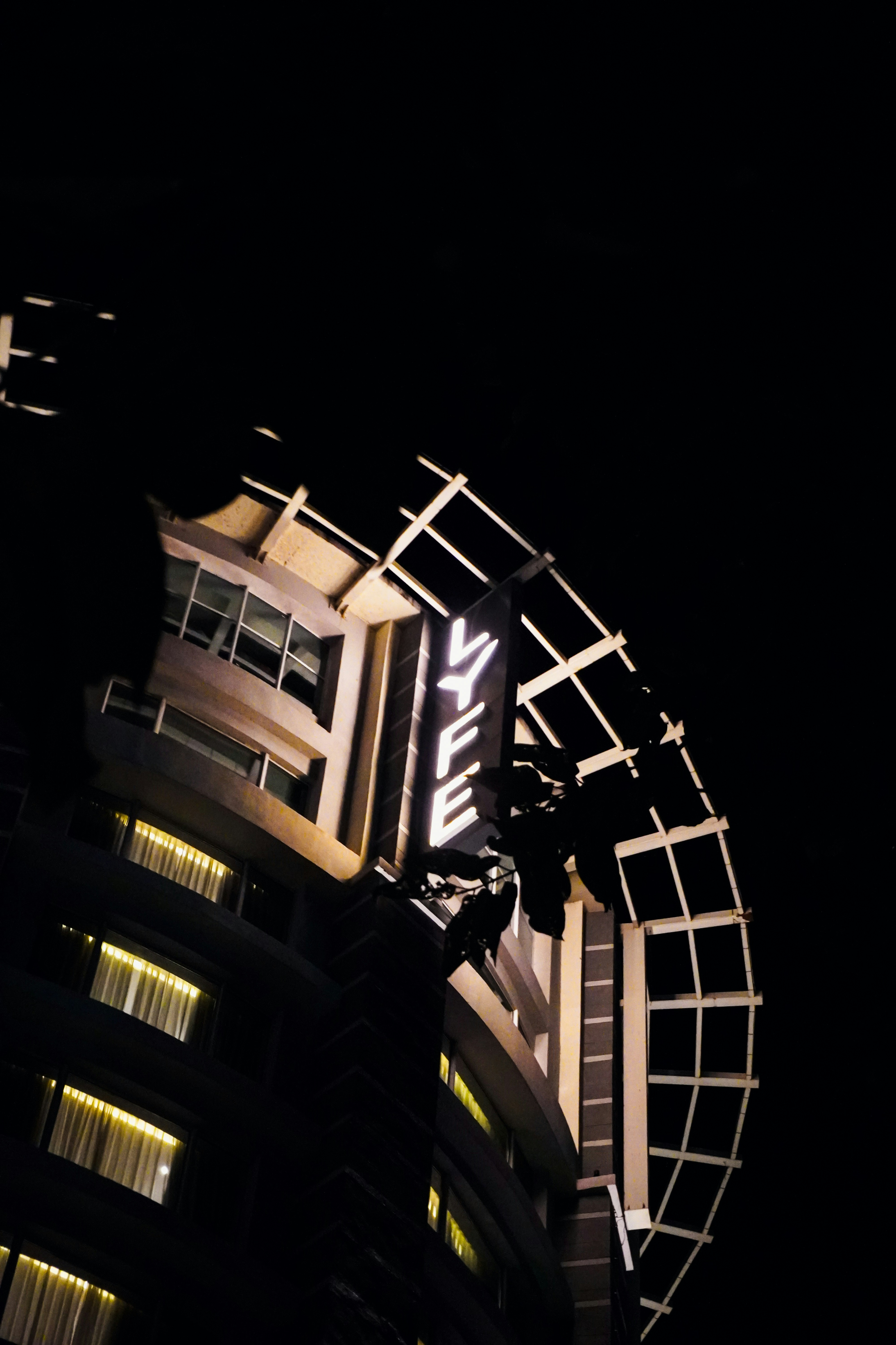 Neon Crown over Vue Cinema: Night Facade within a Circular Frame