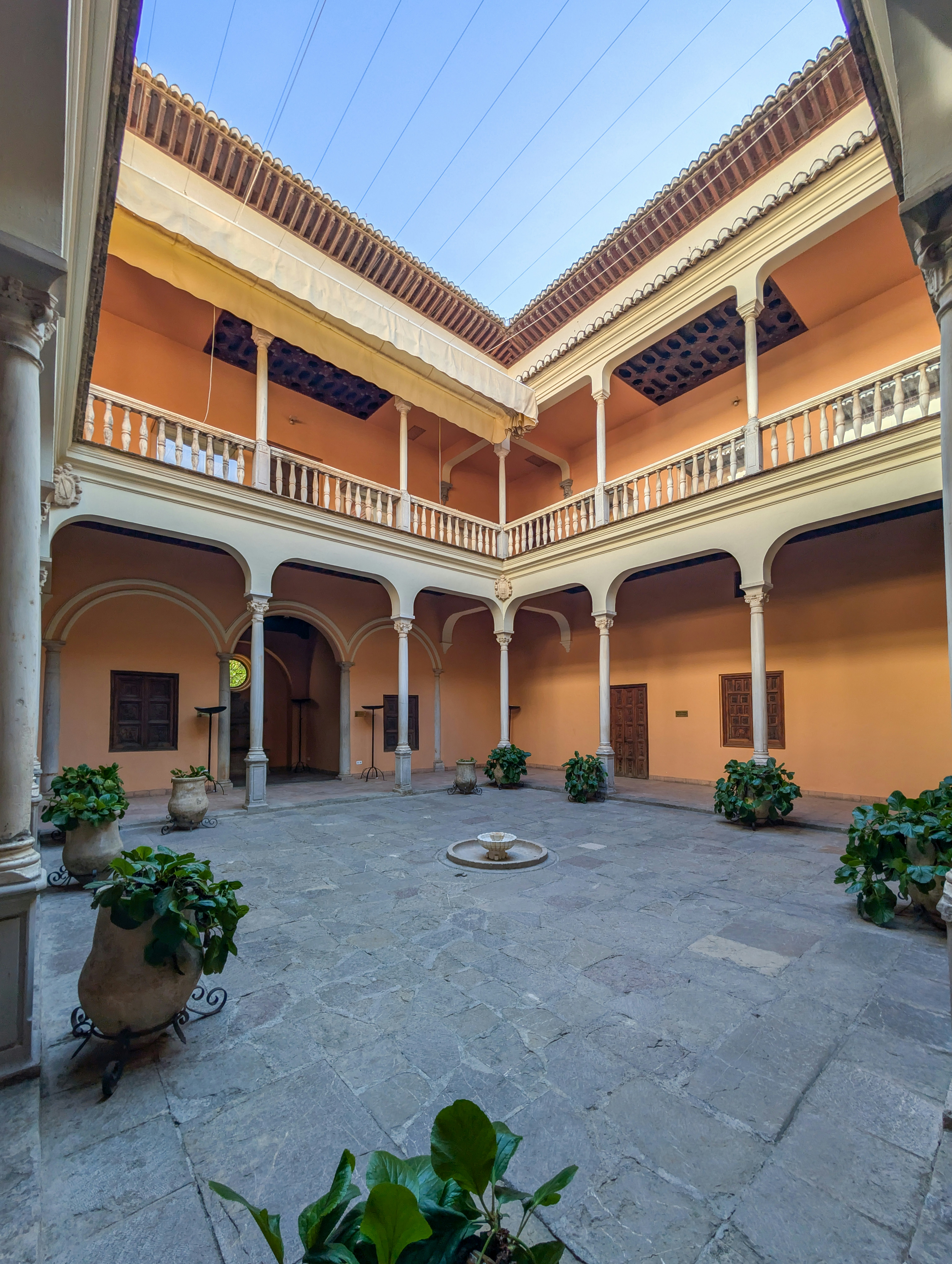 Courtyard with arched walkways and potted plants