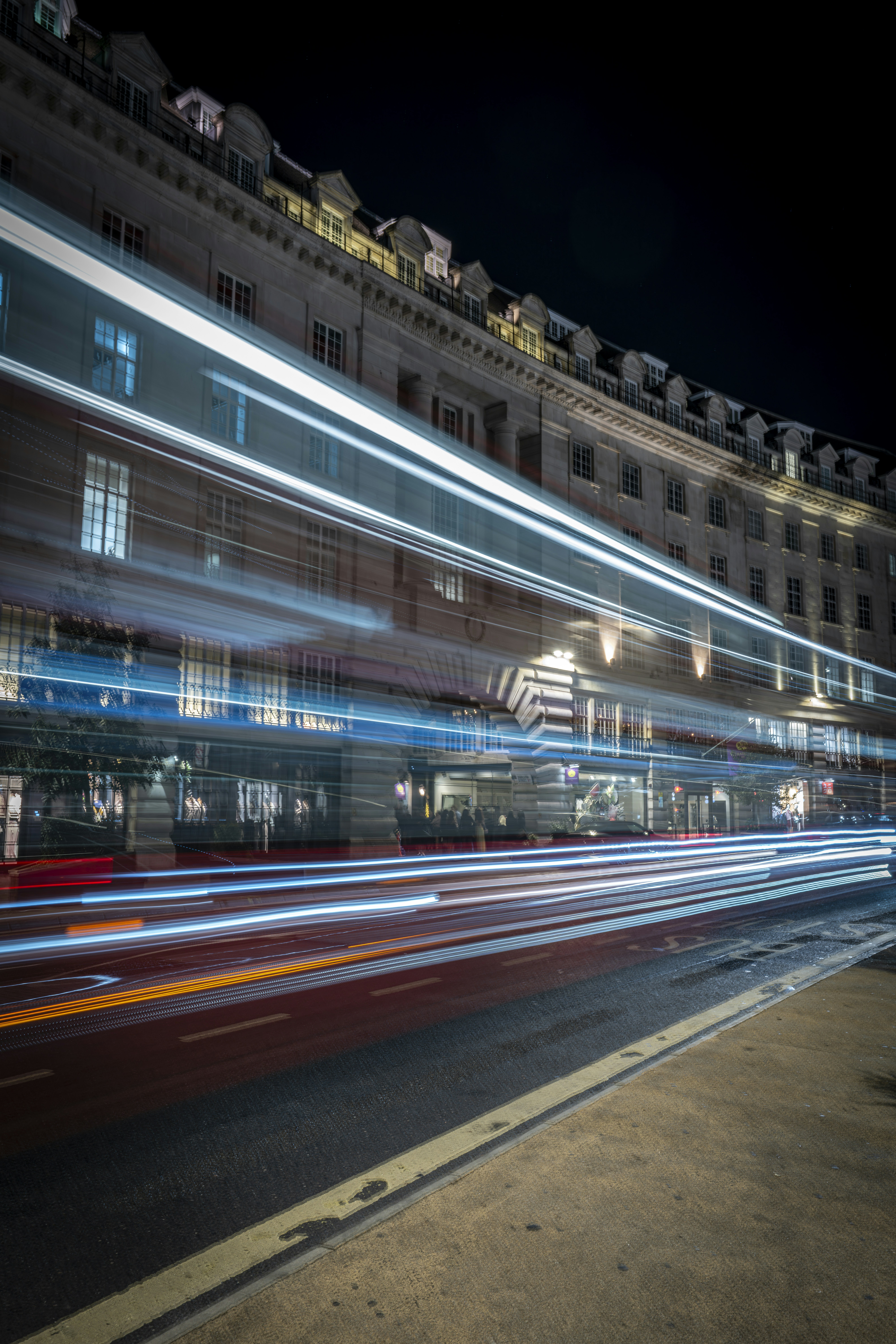 Light trails of vehicles on a city street at night