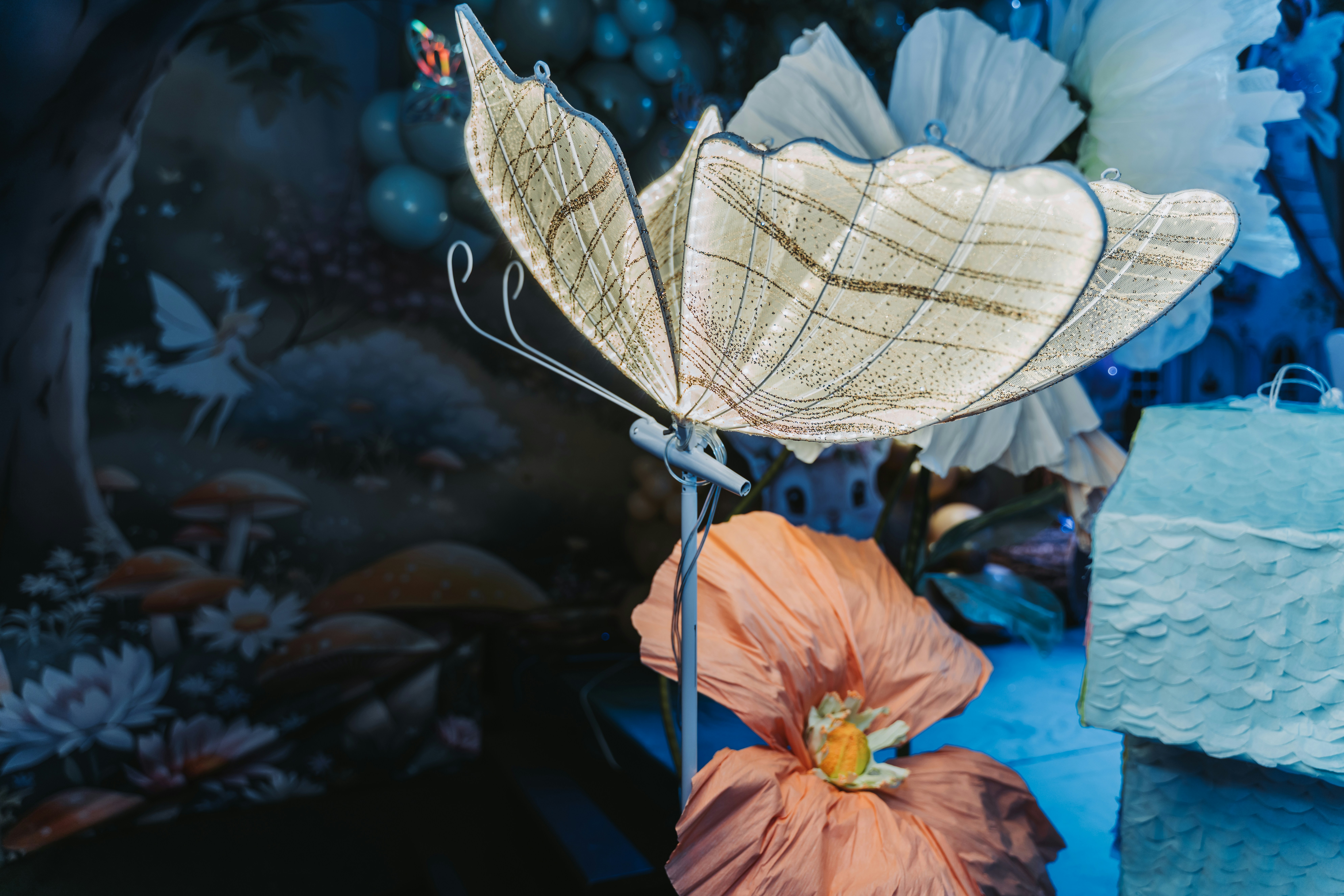 Illuminated butterfly lantern with floral decorations
