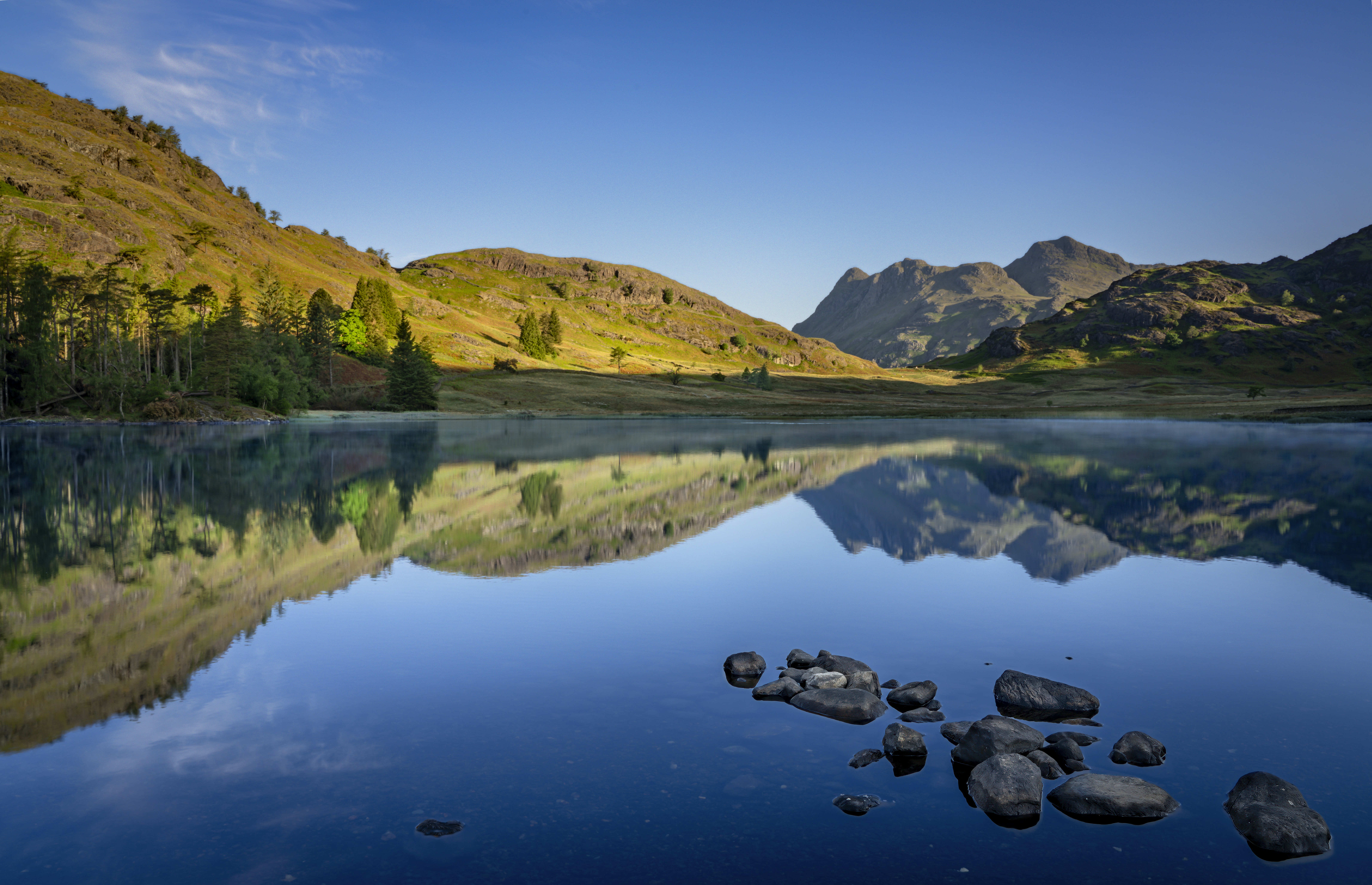 Calm lake reflecting mountains and hills under blue sky. photo – Free ...
