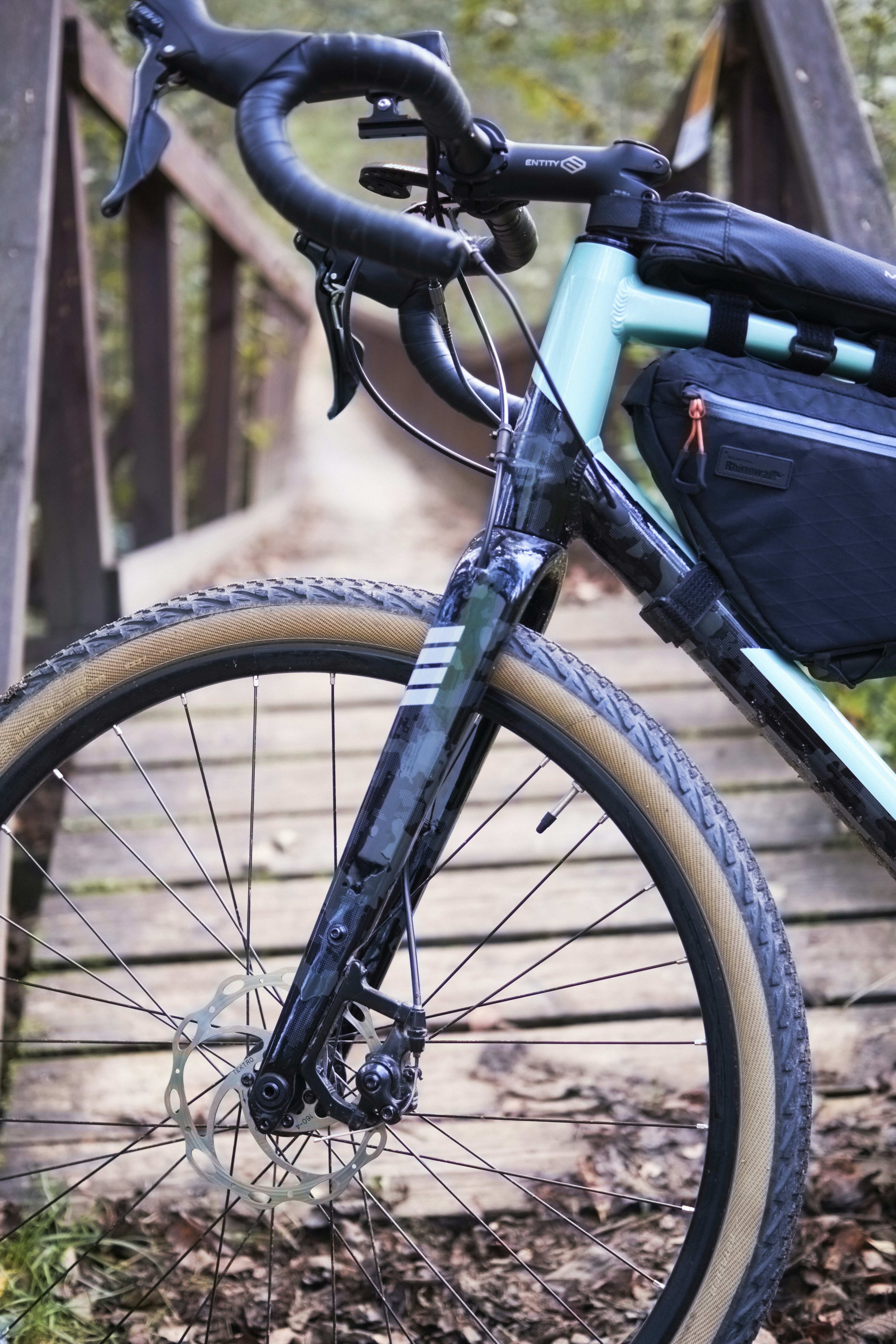 Gravel bicycle with saddlebag on wooden bridge