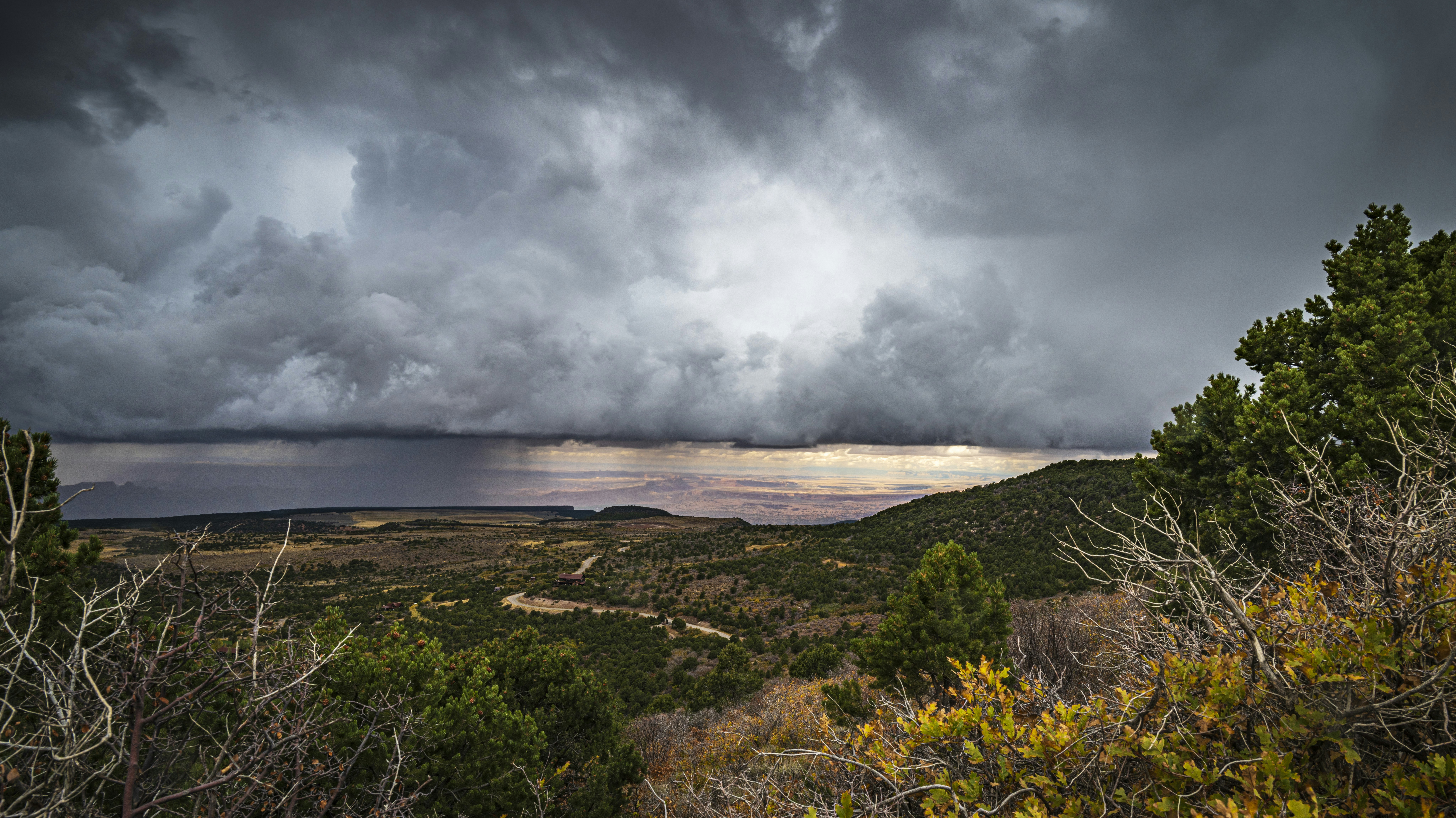 Near Moab | Dramatic storm clouds gather over a vast landscape.