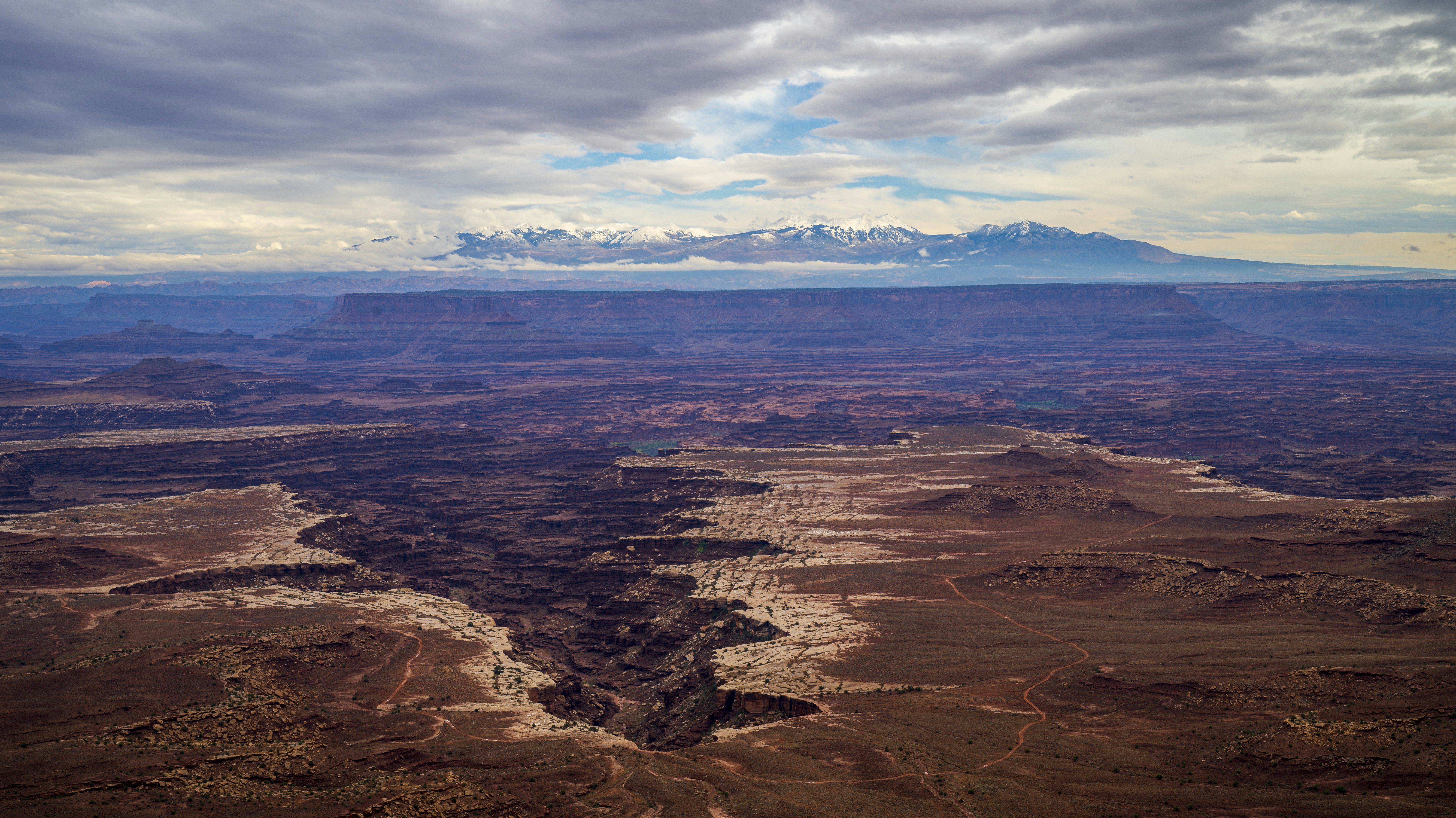 Vast desert canyon landscape under cloudy sky