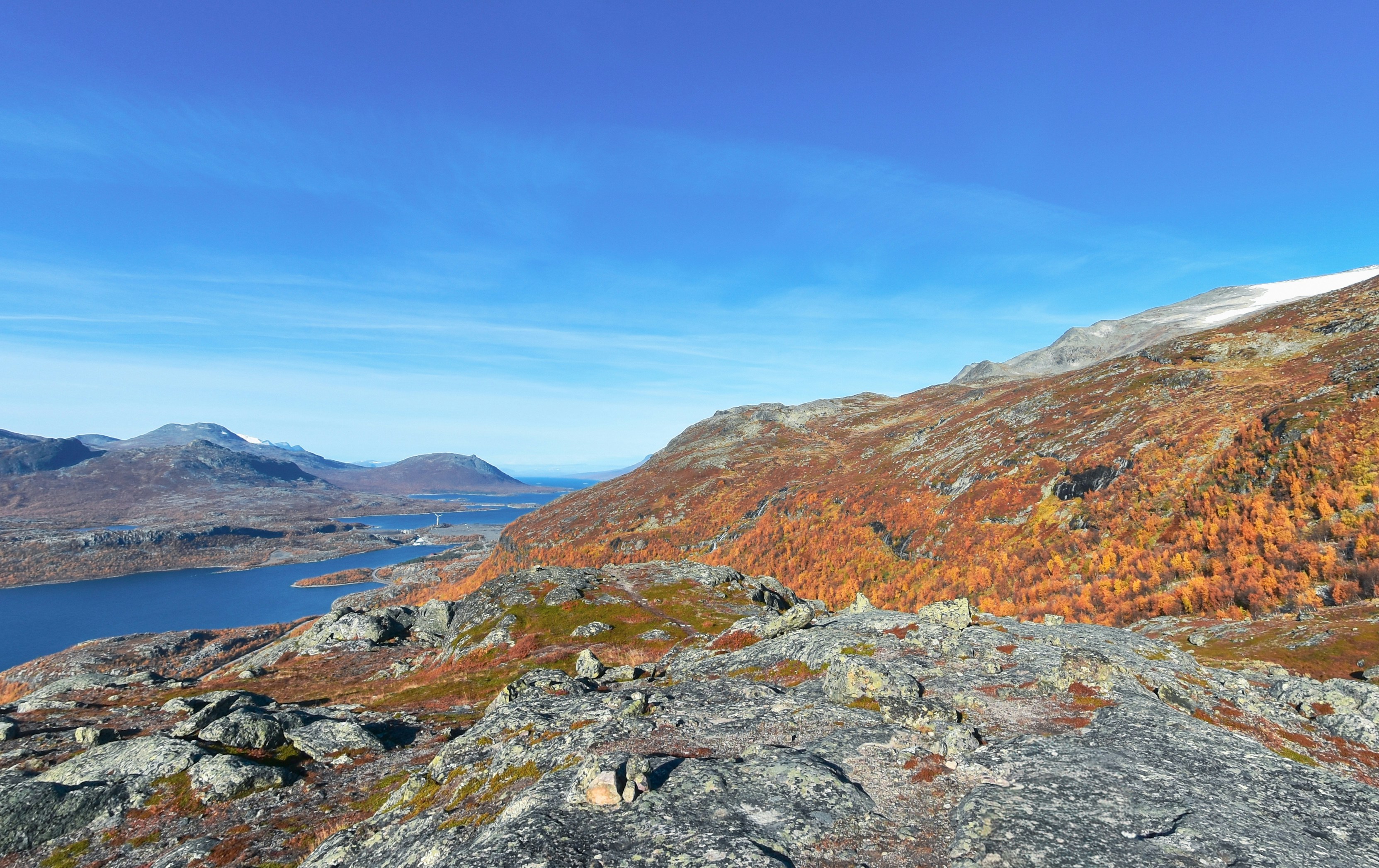 Autumn foliage on a rocky mountainside overlooking a bay.