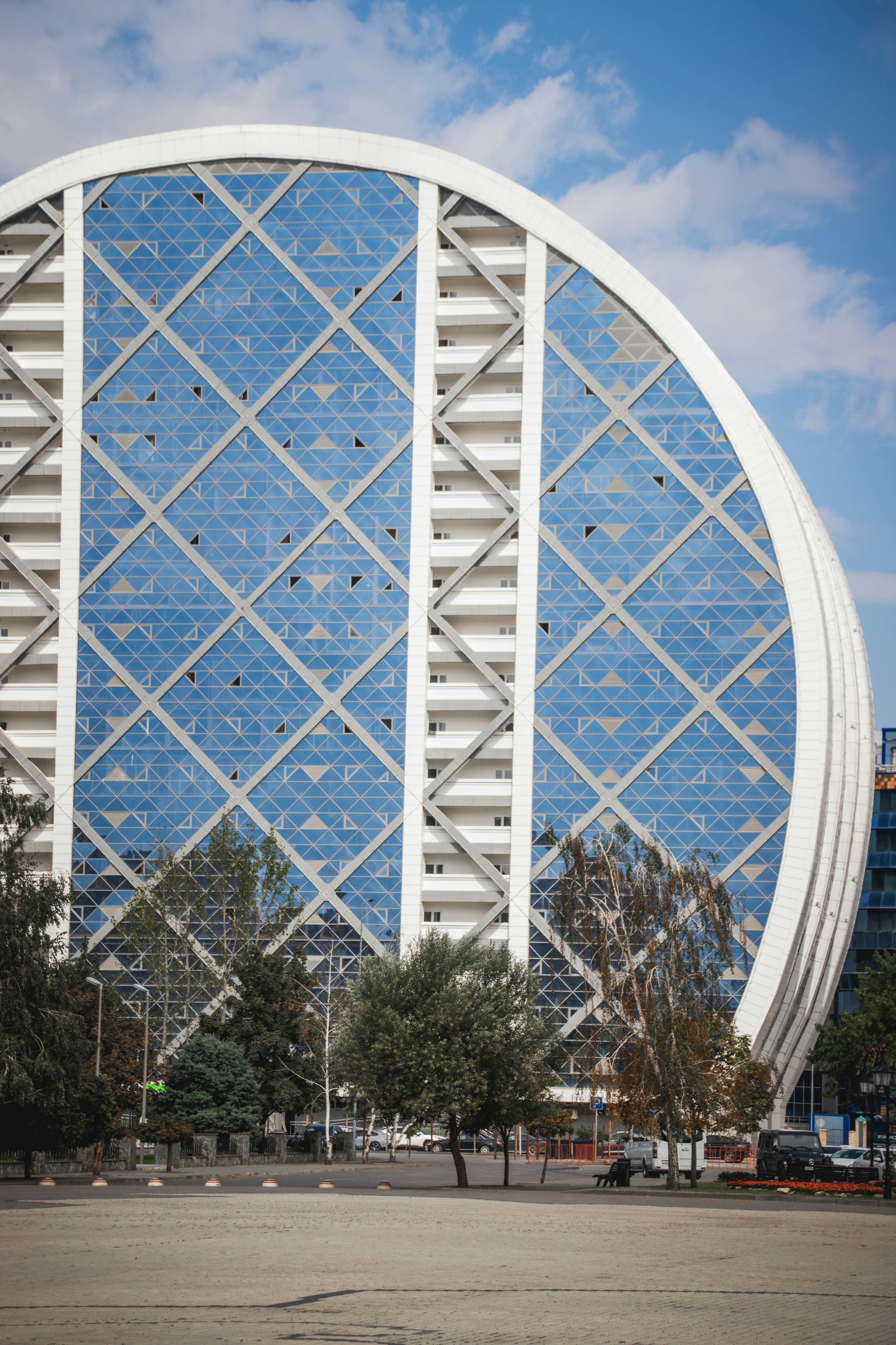 A striking architectural design featuring a blue diamond-patterned facade set against a clear sky, showcasing modern urban aesthetics.