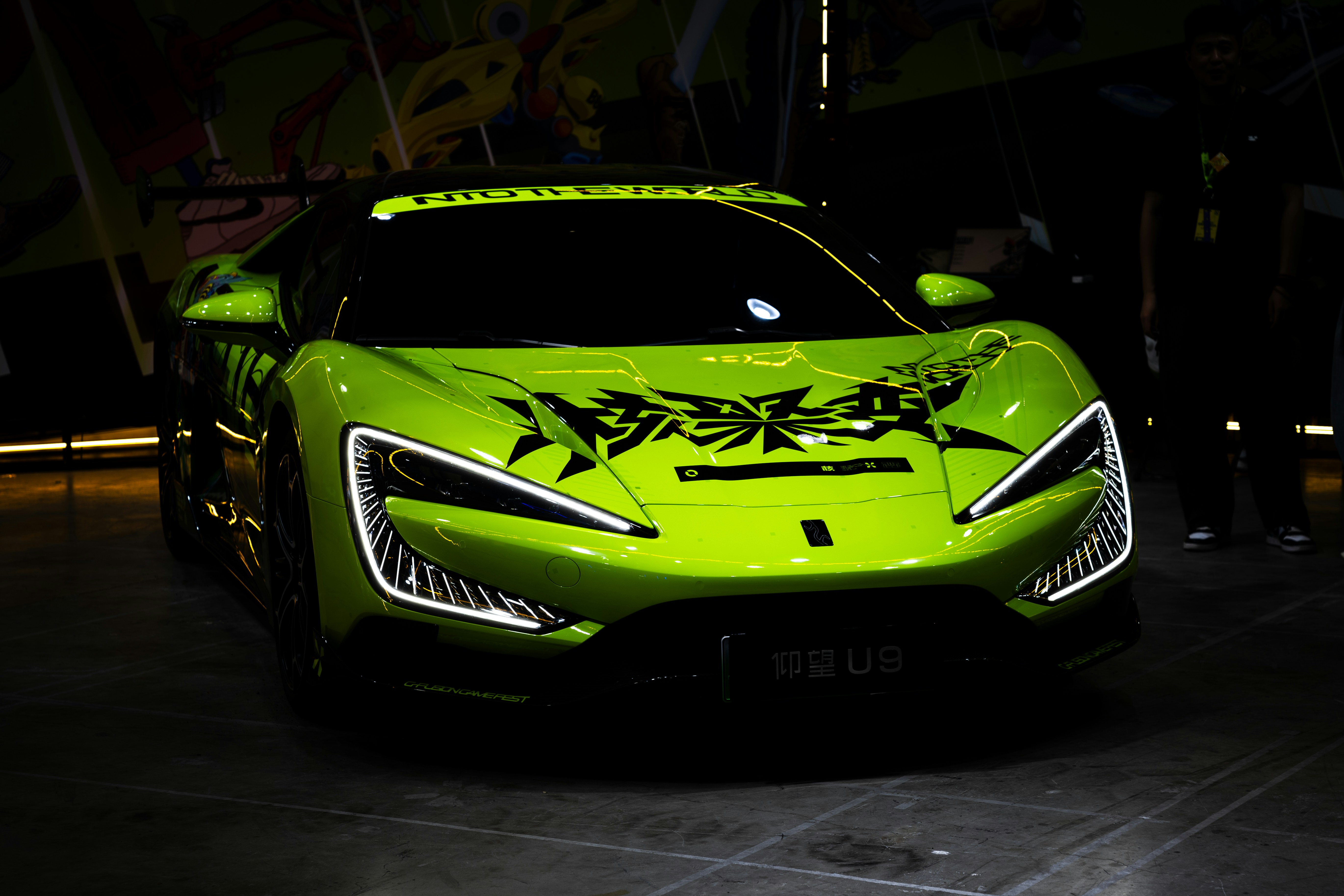 A bright green sports car with black accents.