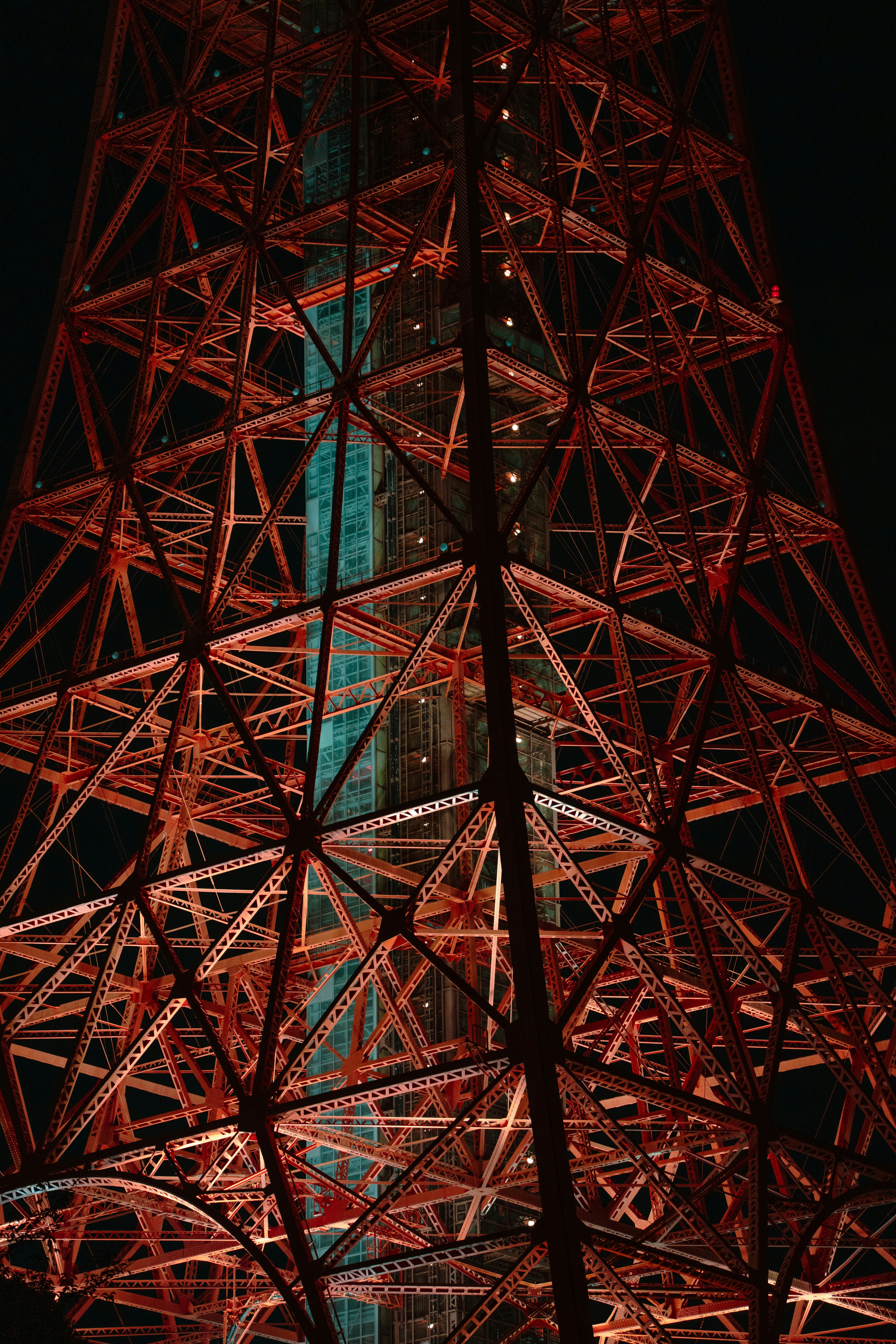 Close-up of a red lattice tower at night