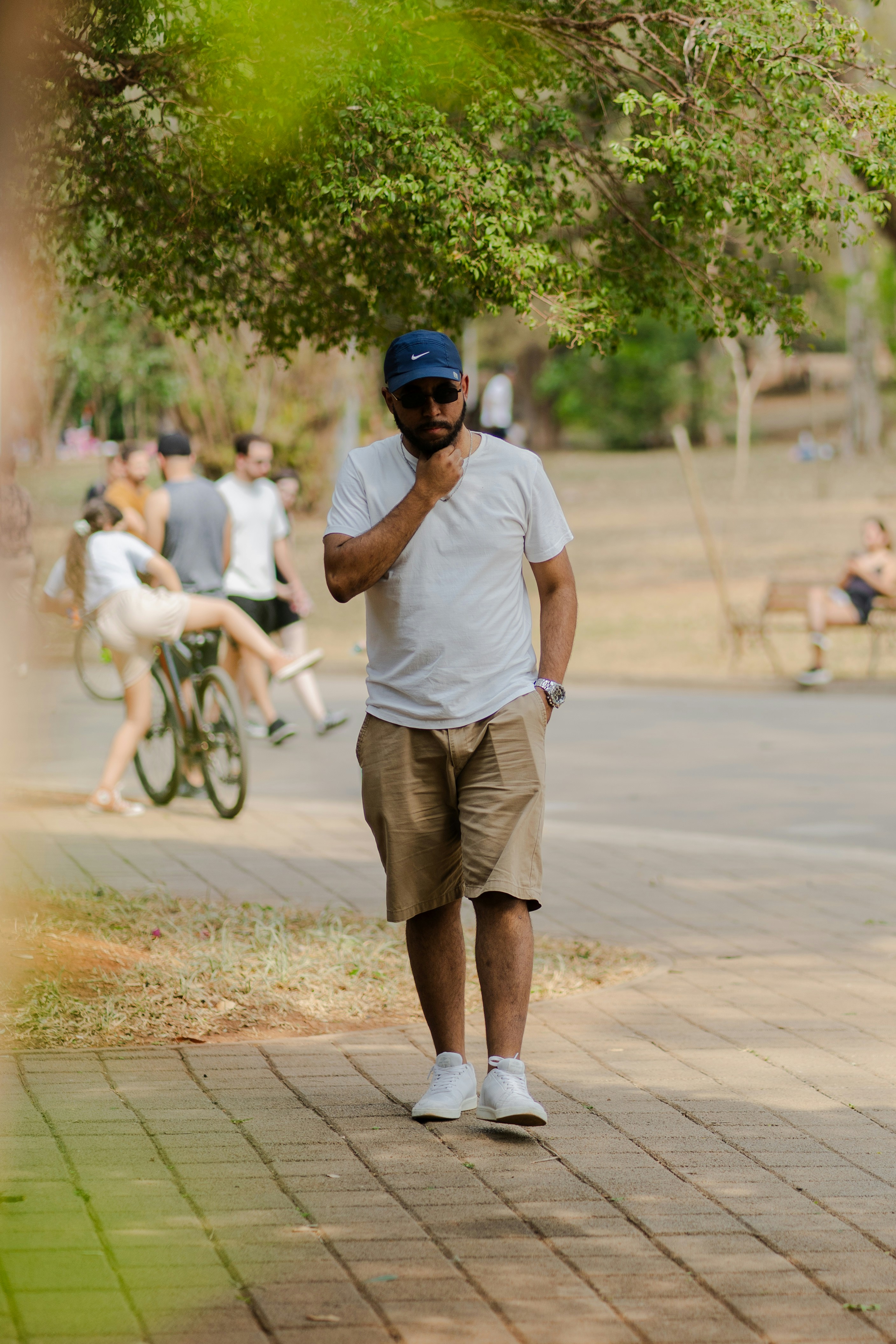 Man in white shirt and shorts walking in park