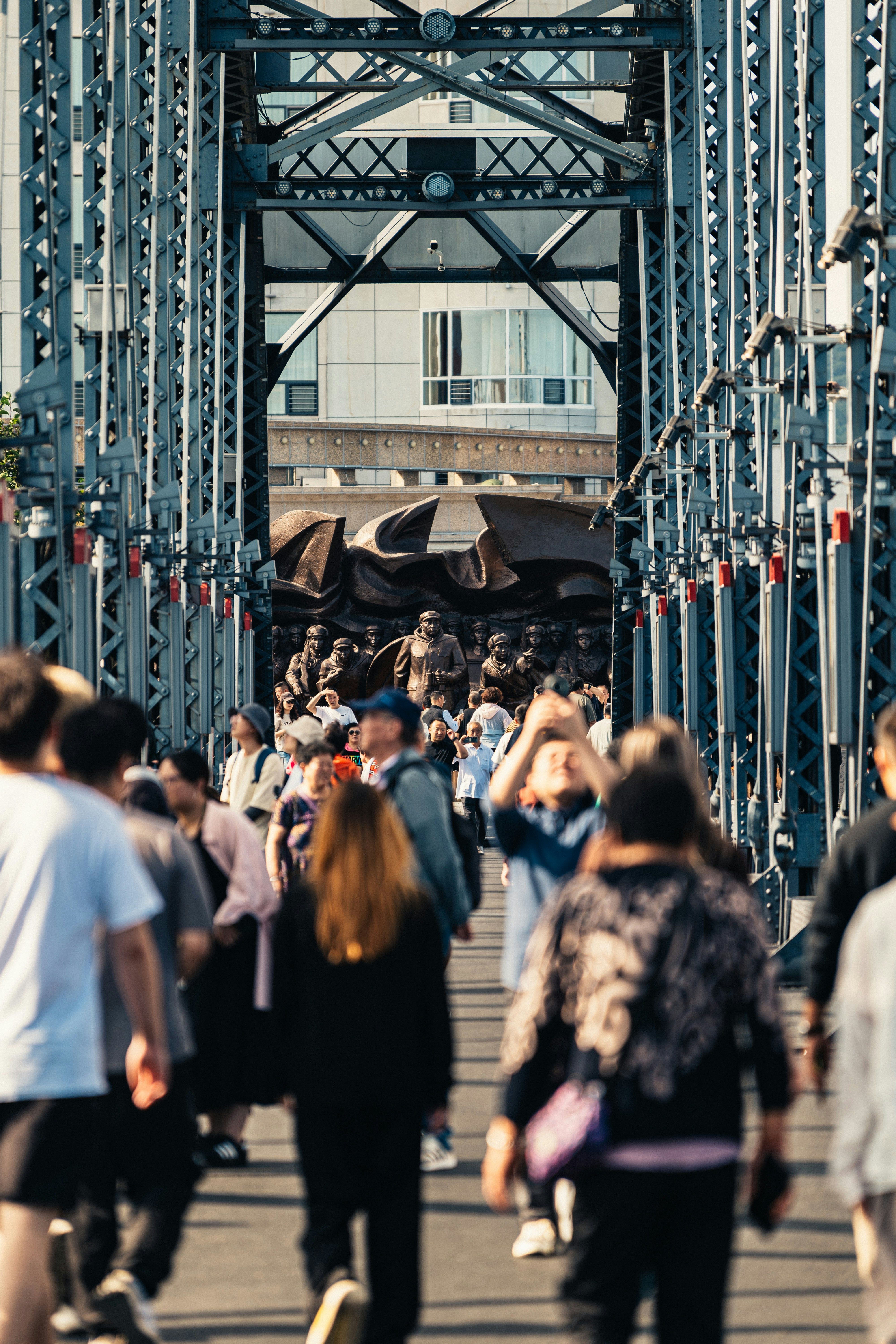 Crowd Currents Beneath Blue Steel Arches