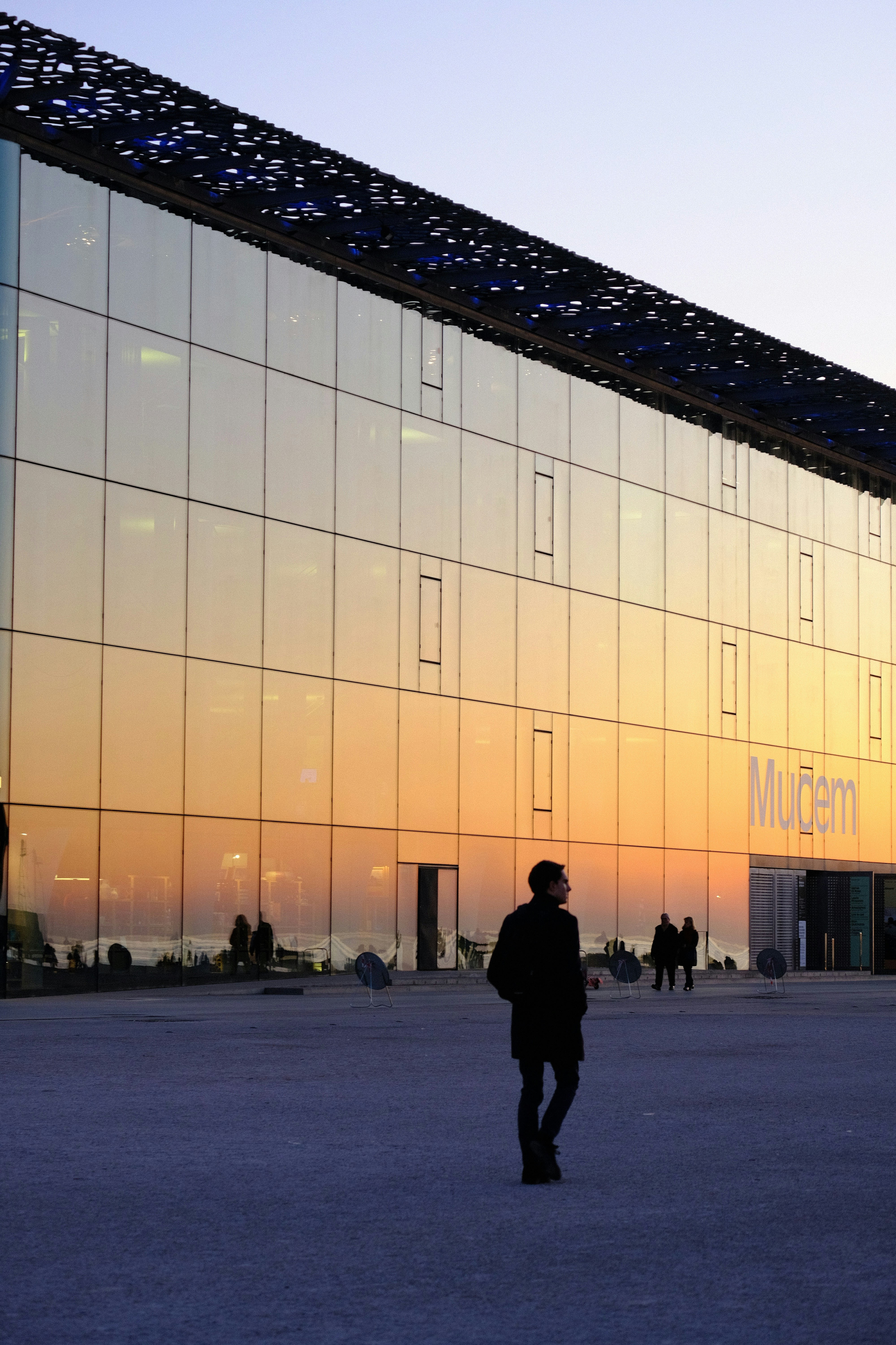 Sunset Silhouette Before the Reflective Mucem Facade