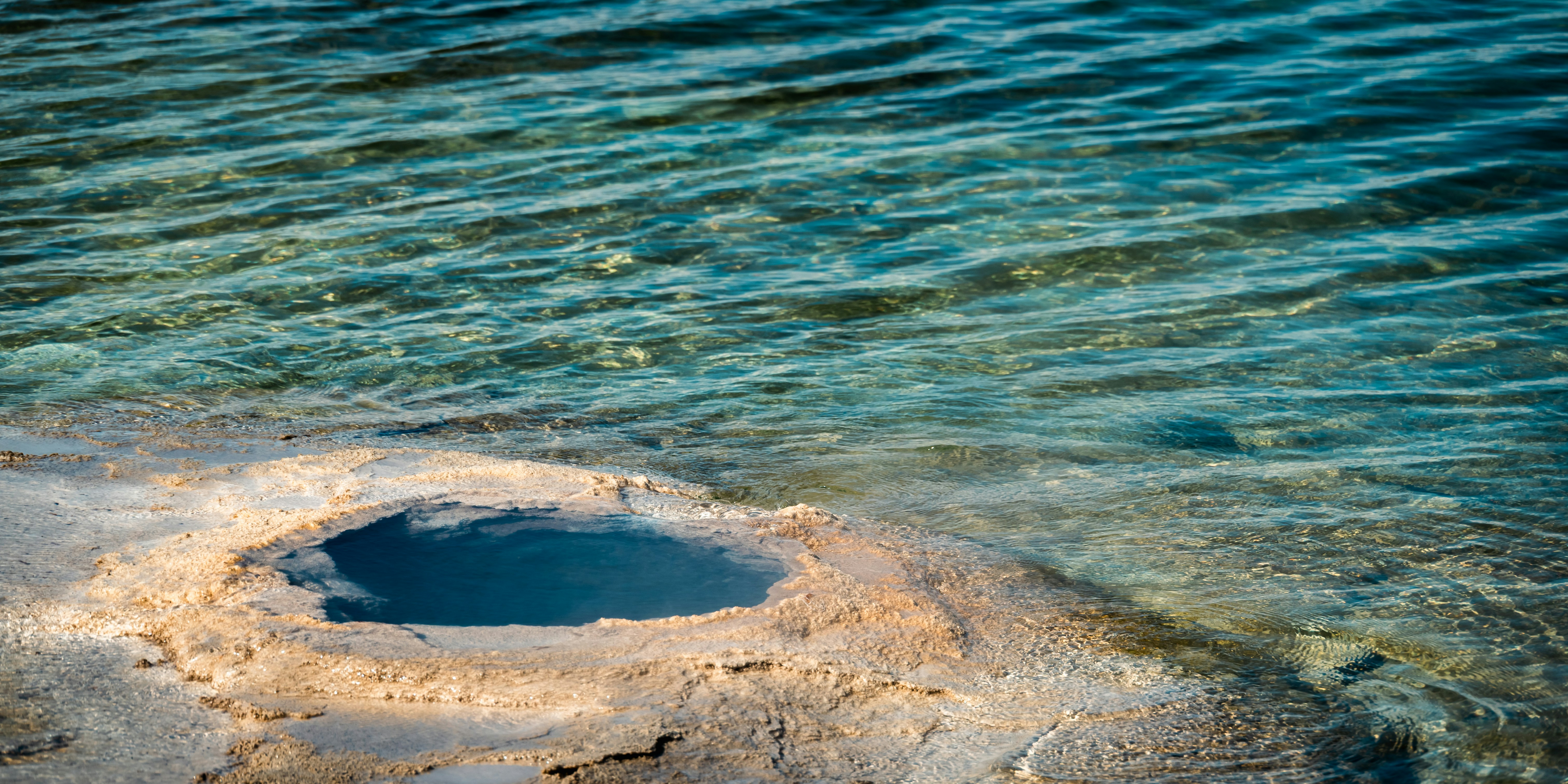 The Turquoise Ring: Circular Rock Pool Fringing a Sunlit Shore
