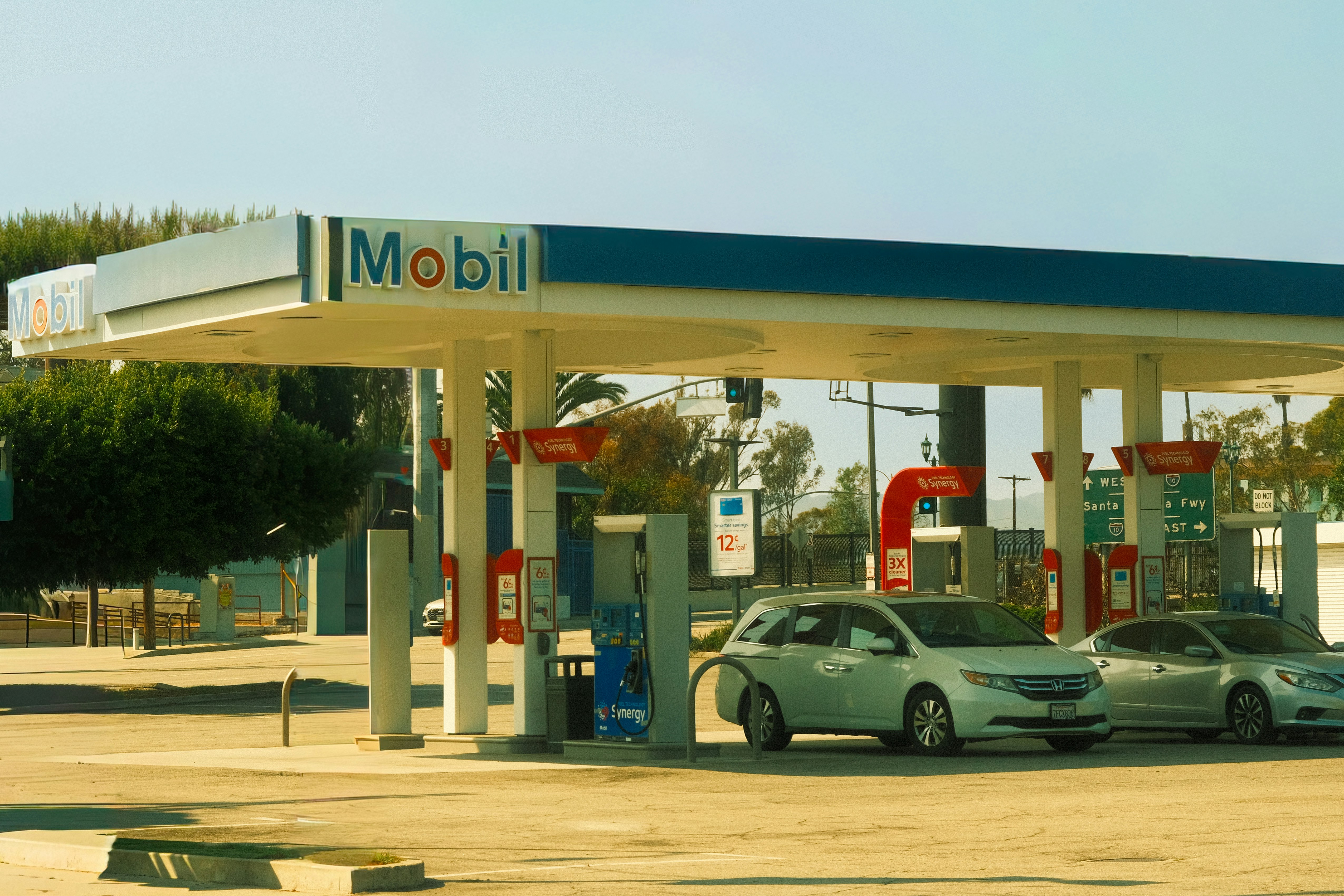 Mobil gas station with cars at pumps