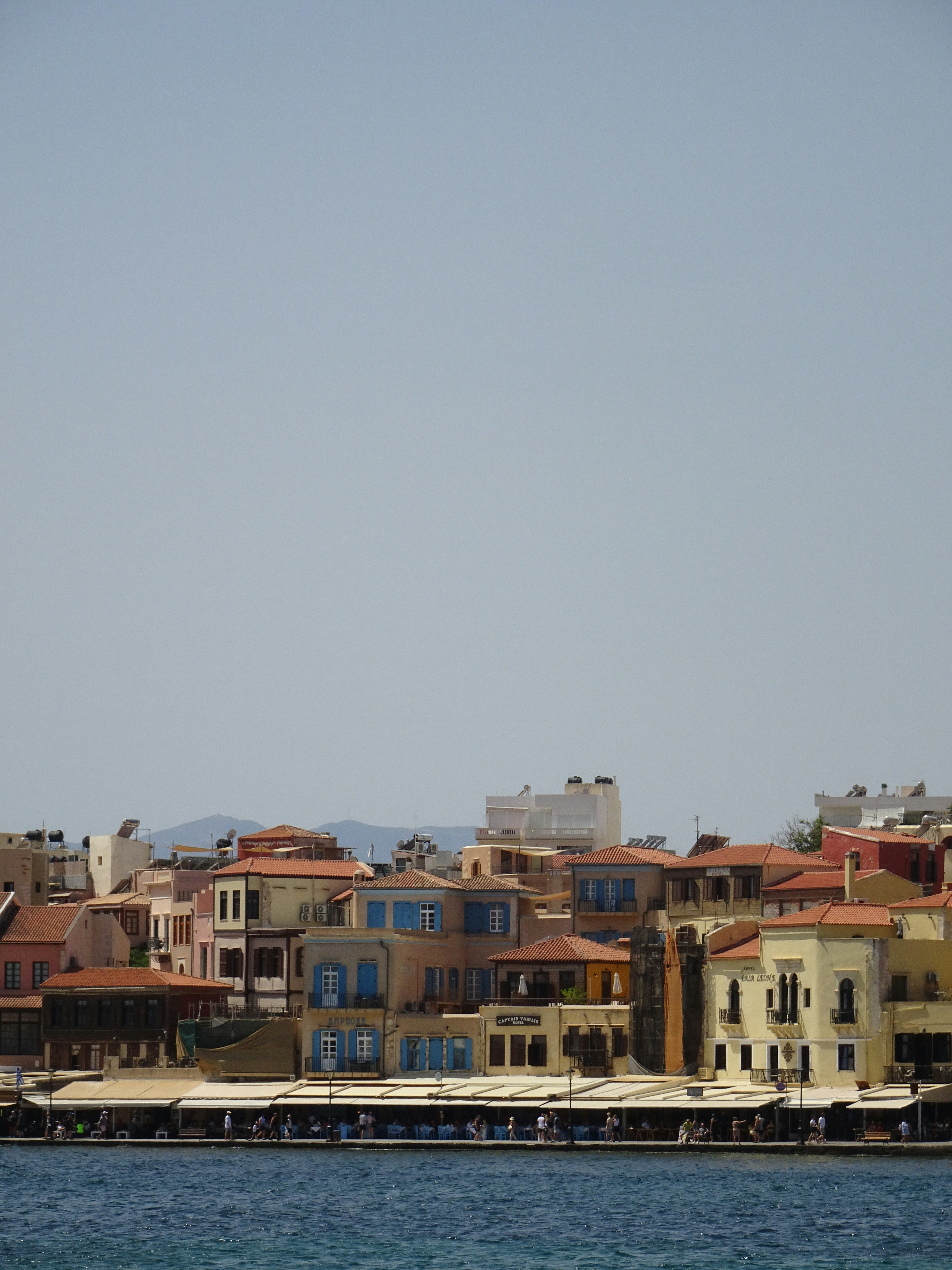 Colorful houses | Colorful buildings line the waterfront under a clear sky.