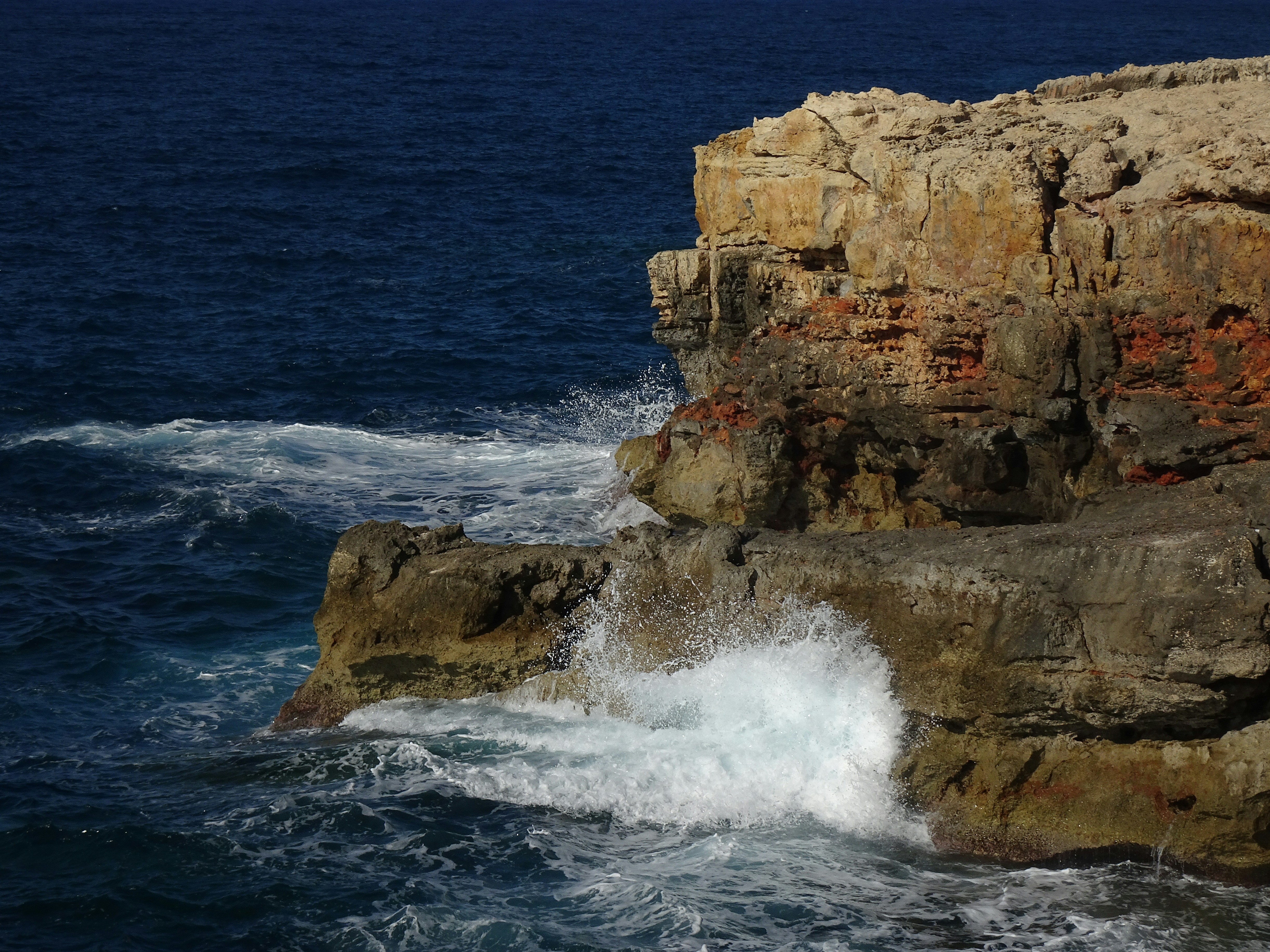Sea and rocks | Waves crashing against rocky cliffs by the sea.