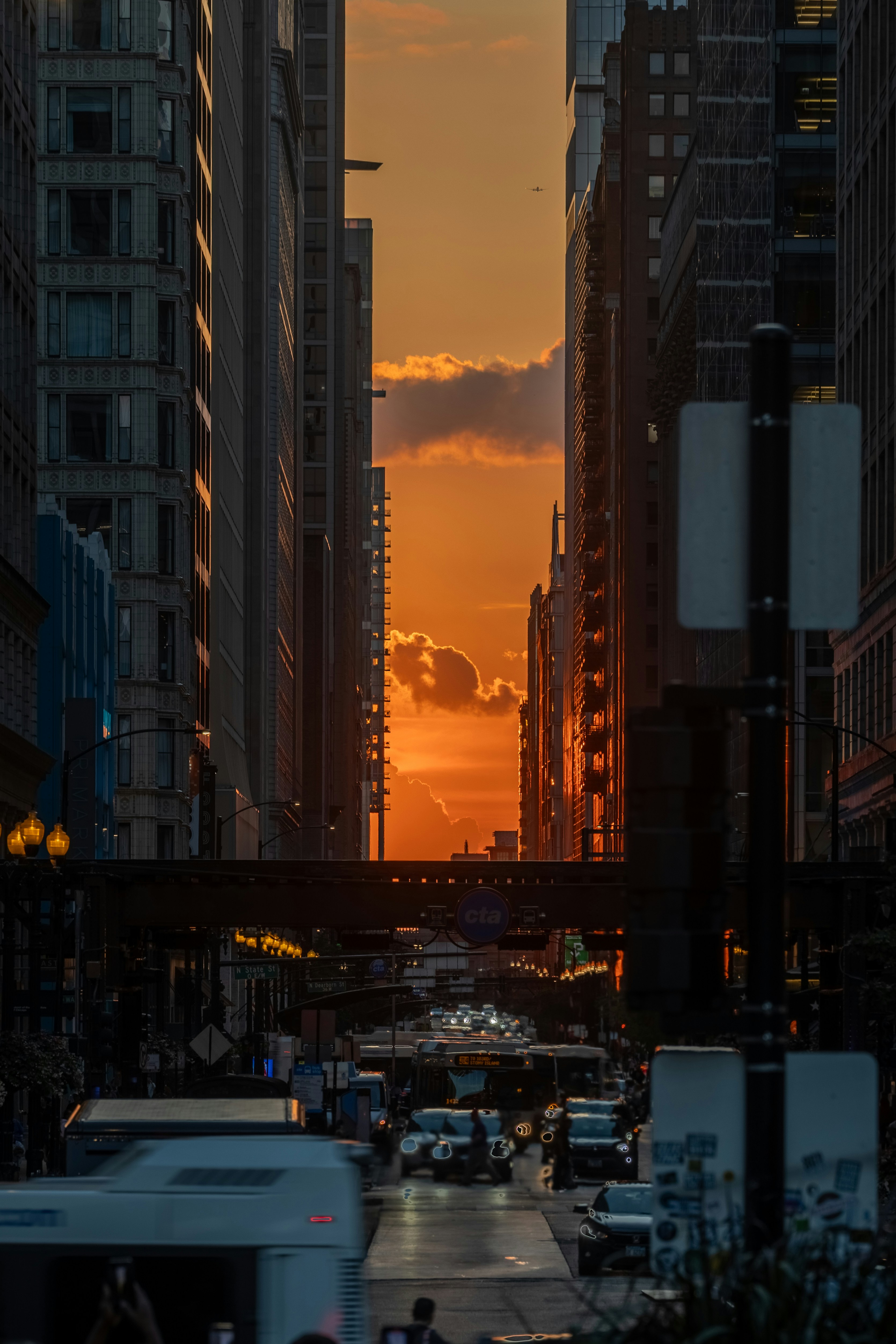 City street at sunset with dramatic orange sky.