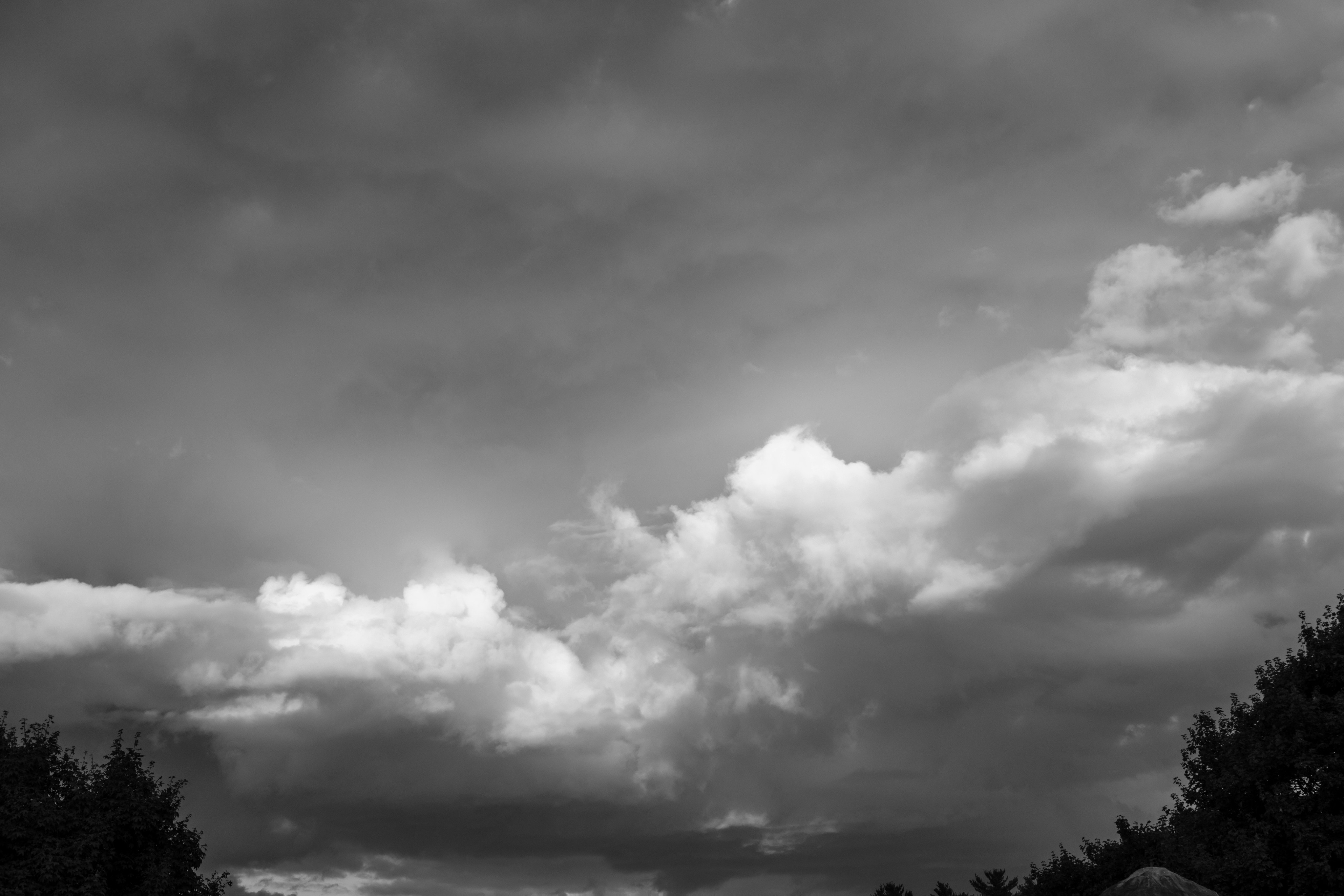 Dramatic clouds gather in a stormy sky.