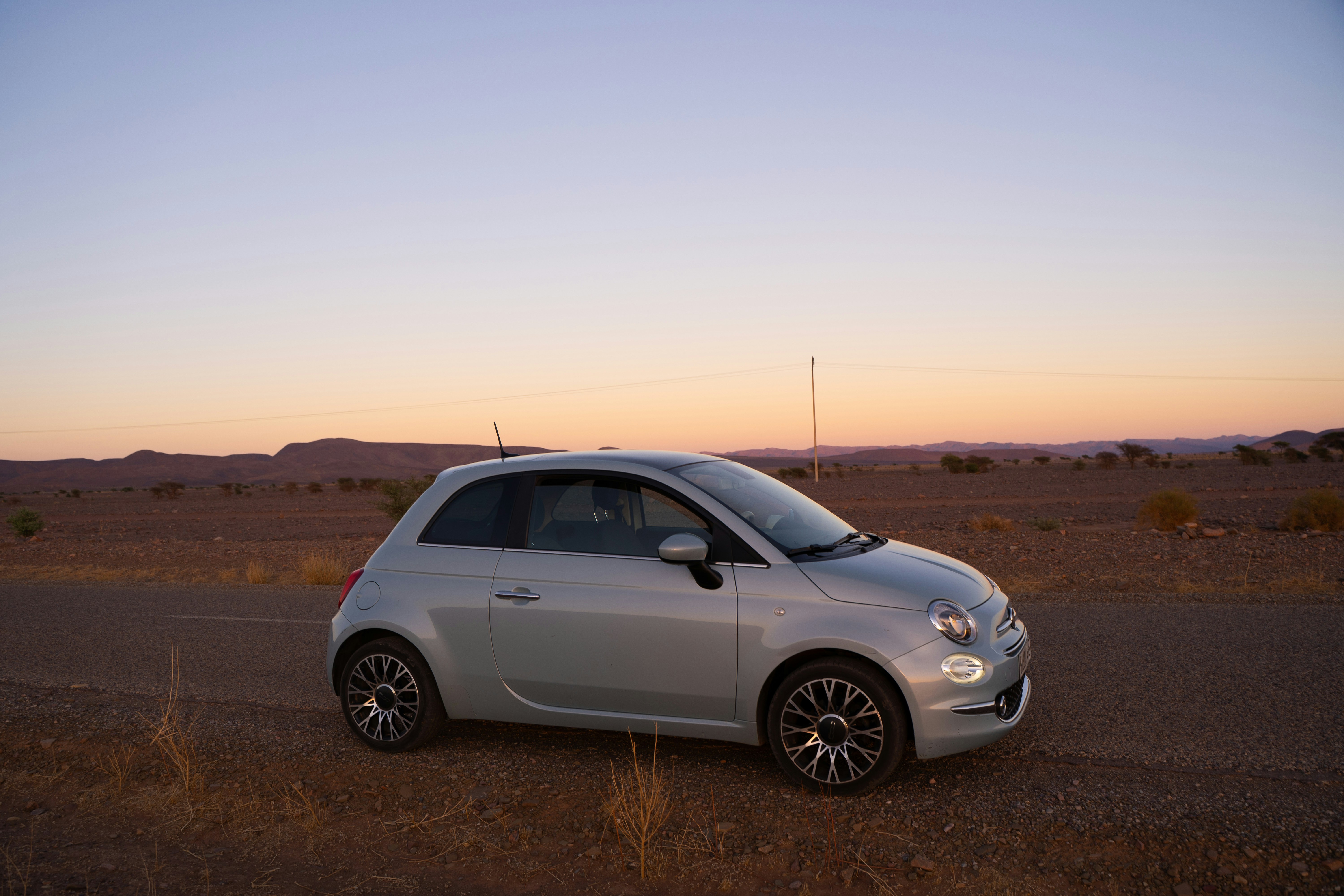Desert Journey: A Silver Compact in the Twilight