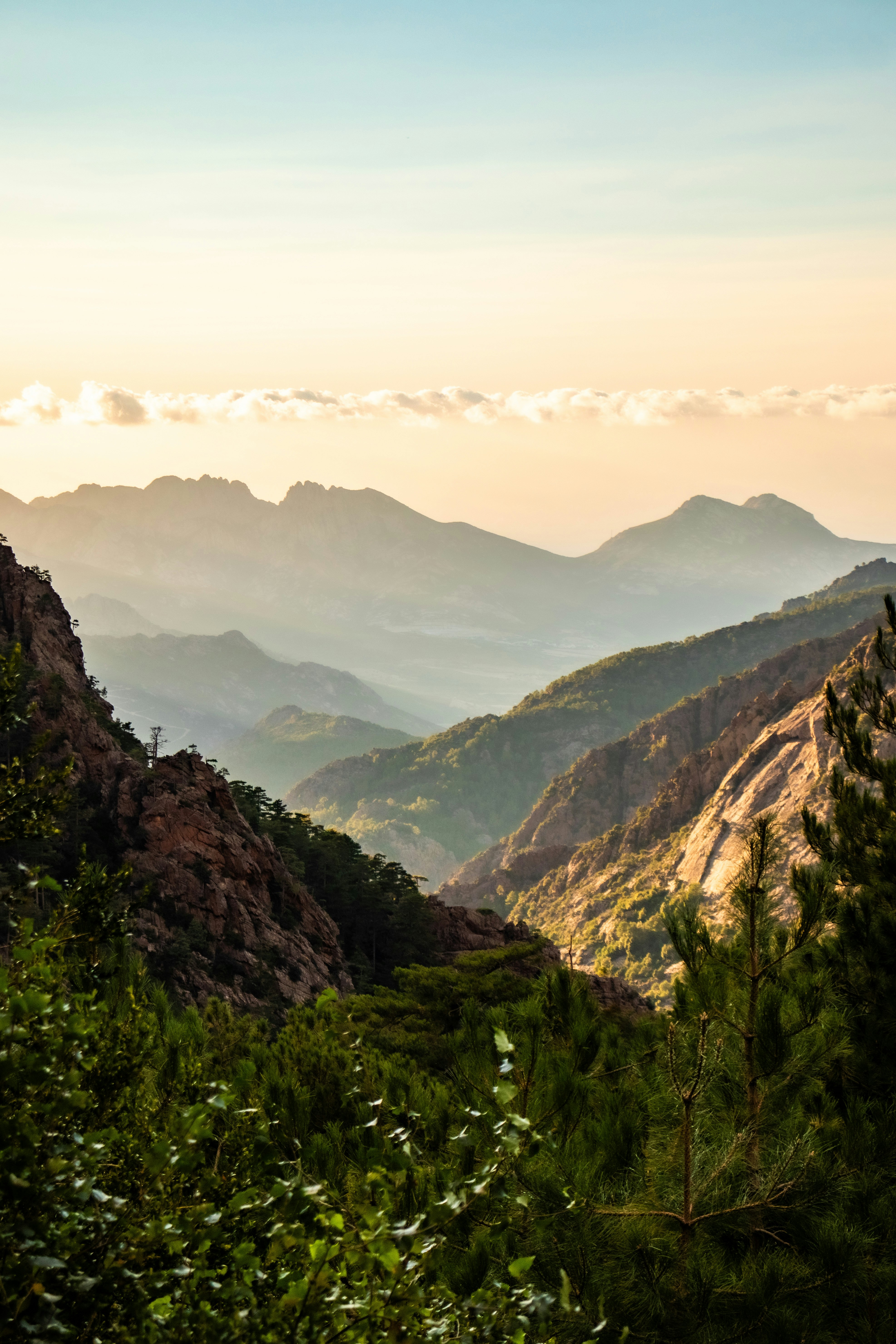 Corsican mountains | Layered mountain ranges bathed in soft golden light.
