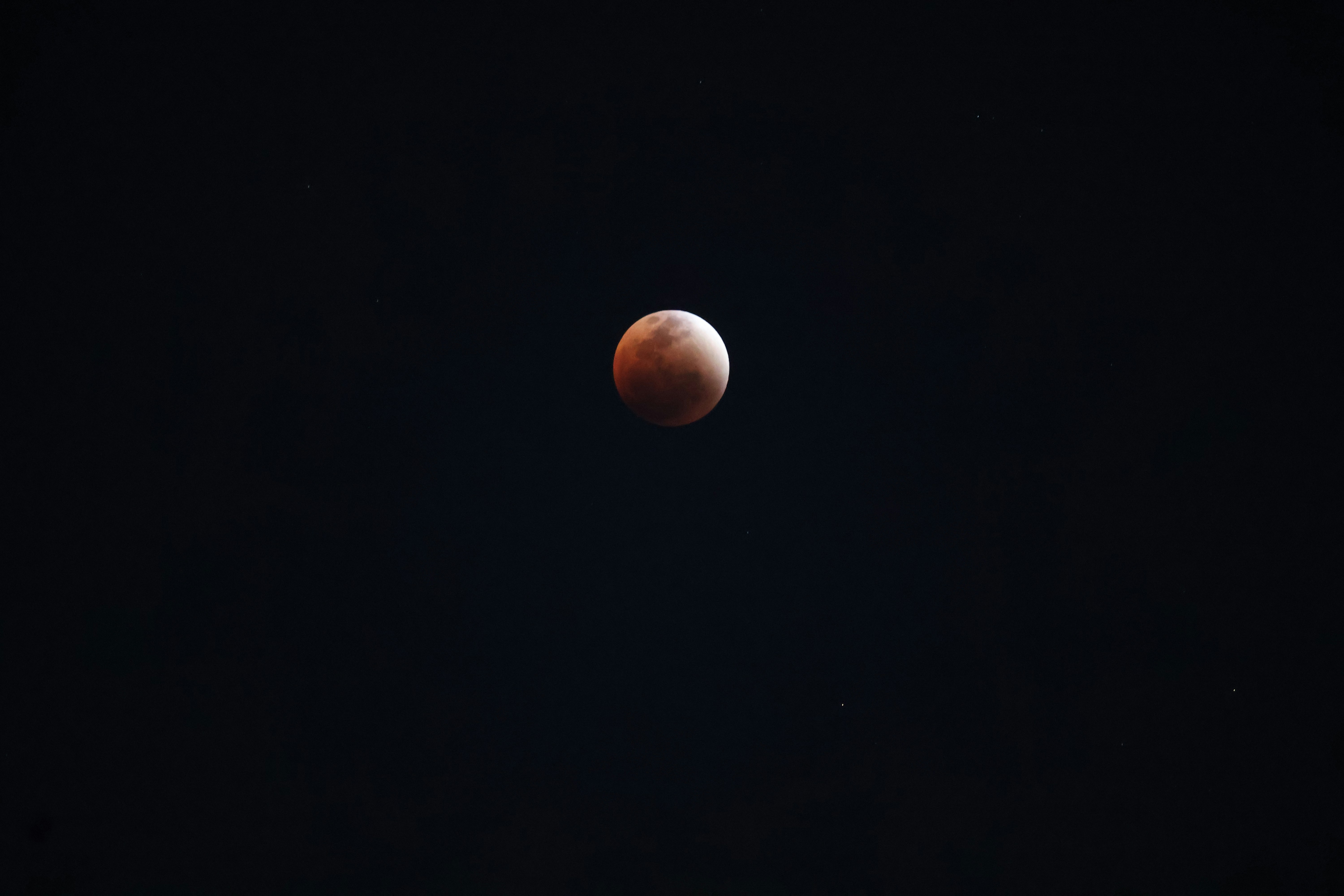 Blood moon taken from Jhb, South Africa on 7th September 2025 | A blood moon hangs in a dark night sky.