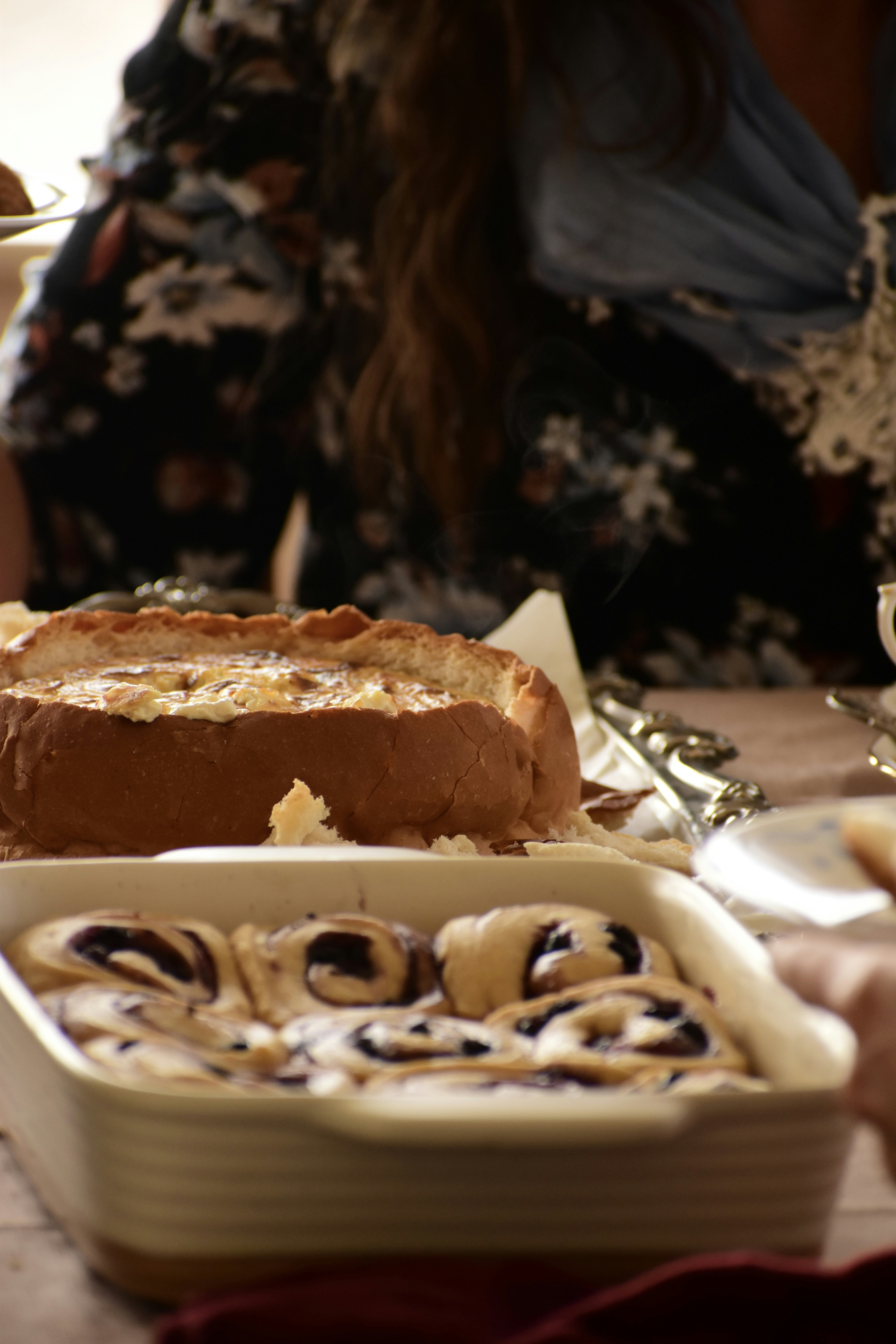 Comfort food | Freshly baked cinnamon rolls and bread bowl on a table