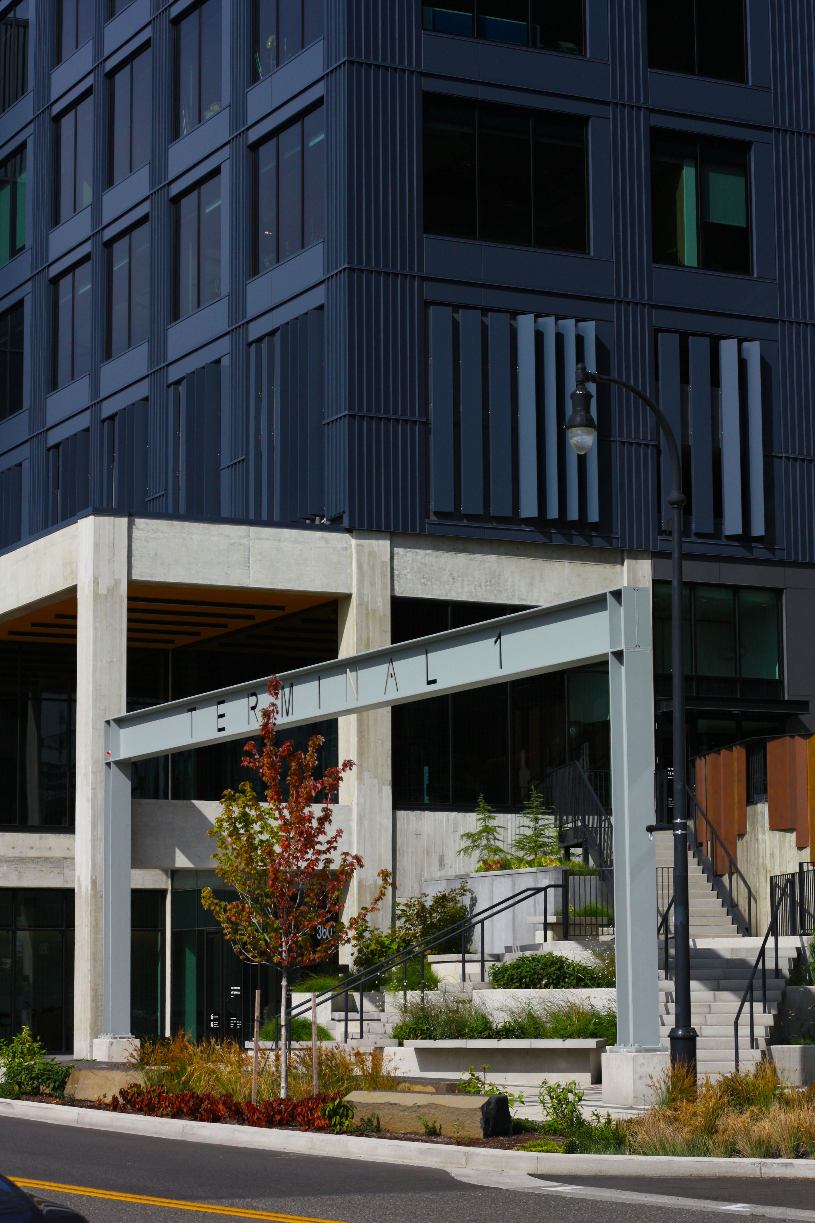 Modern building entrance with concrete and metal details.