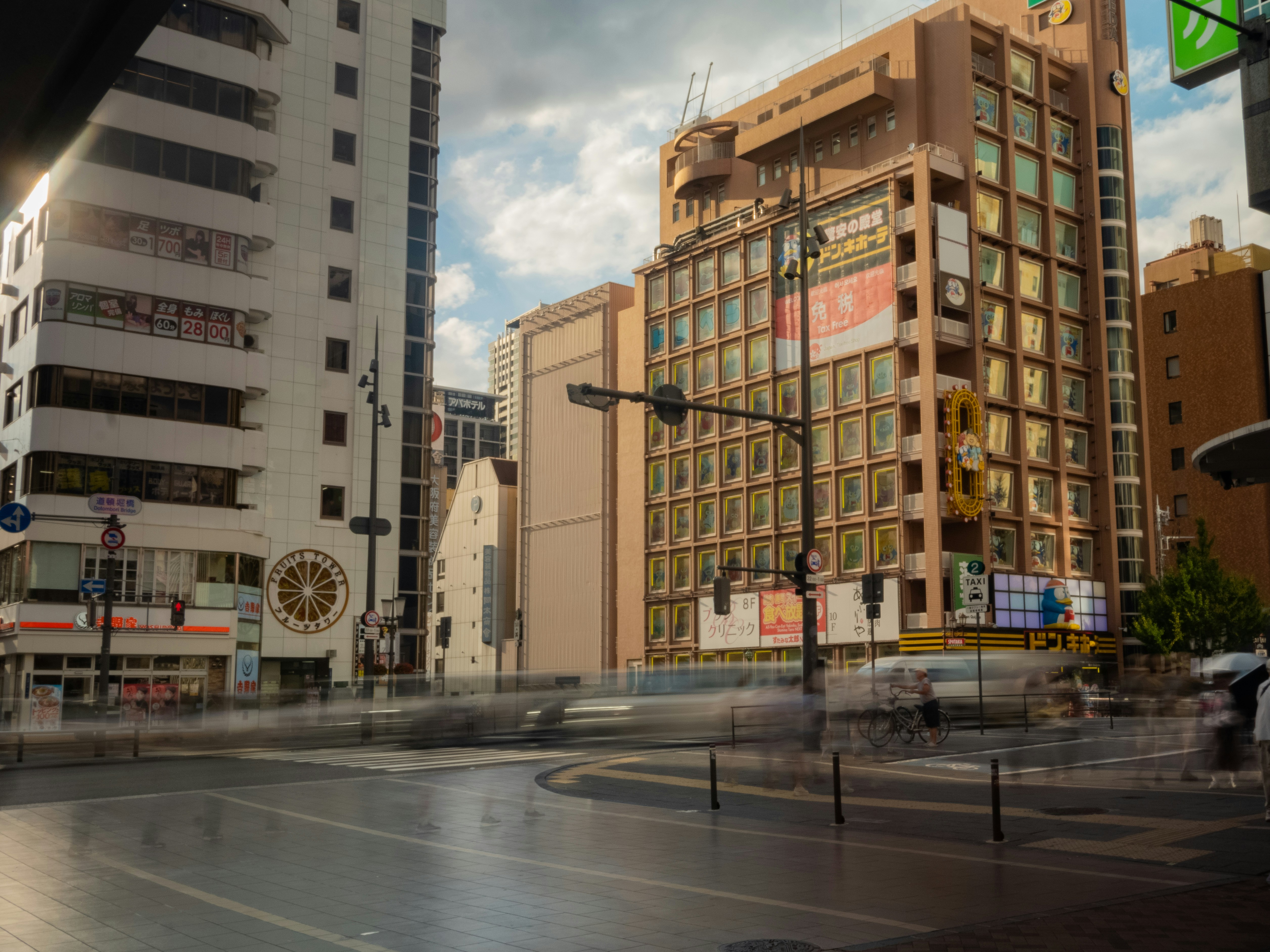 Sunlit Crossroads Beneath Sign-Drenched Towers