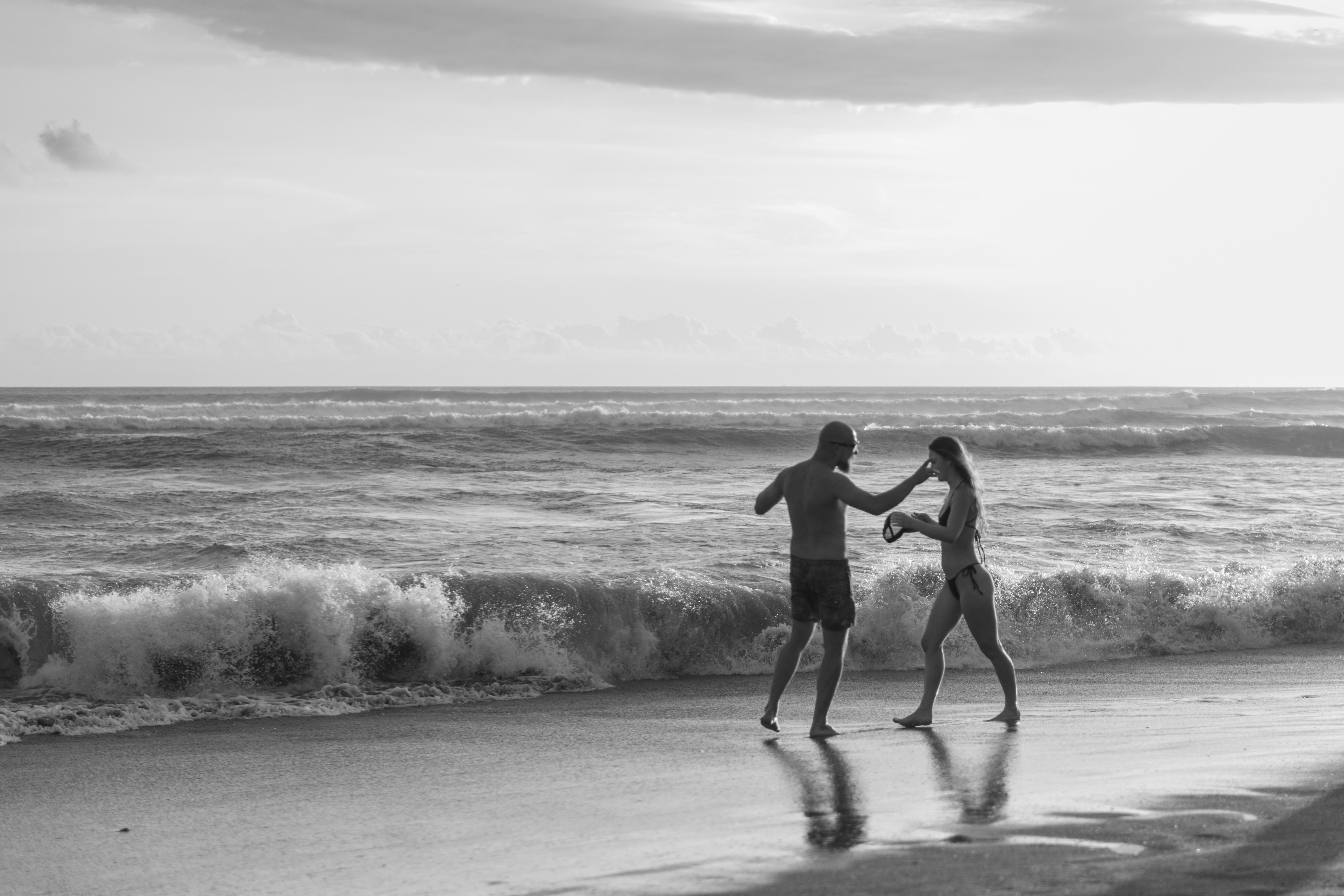 Couple dancing on a beach at sunset