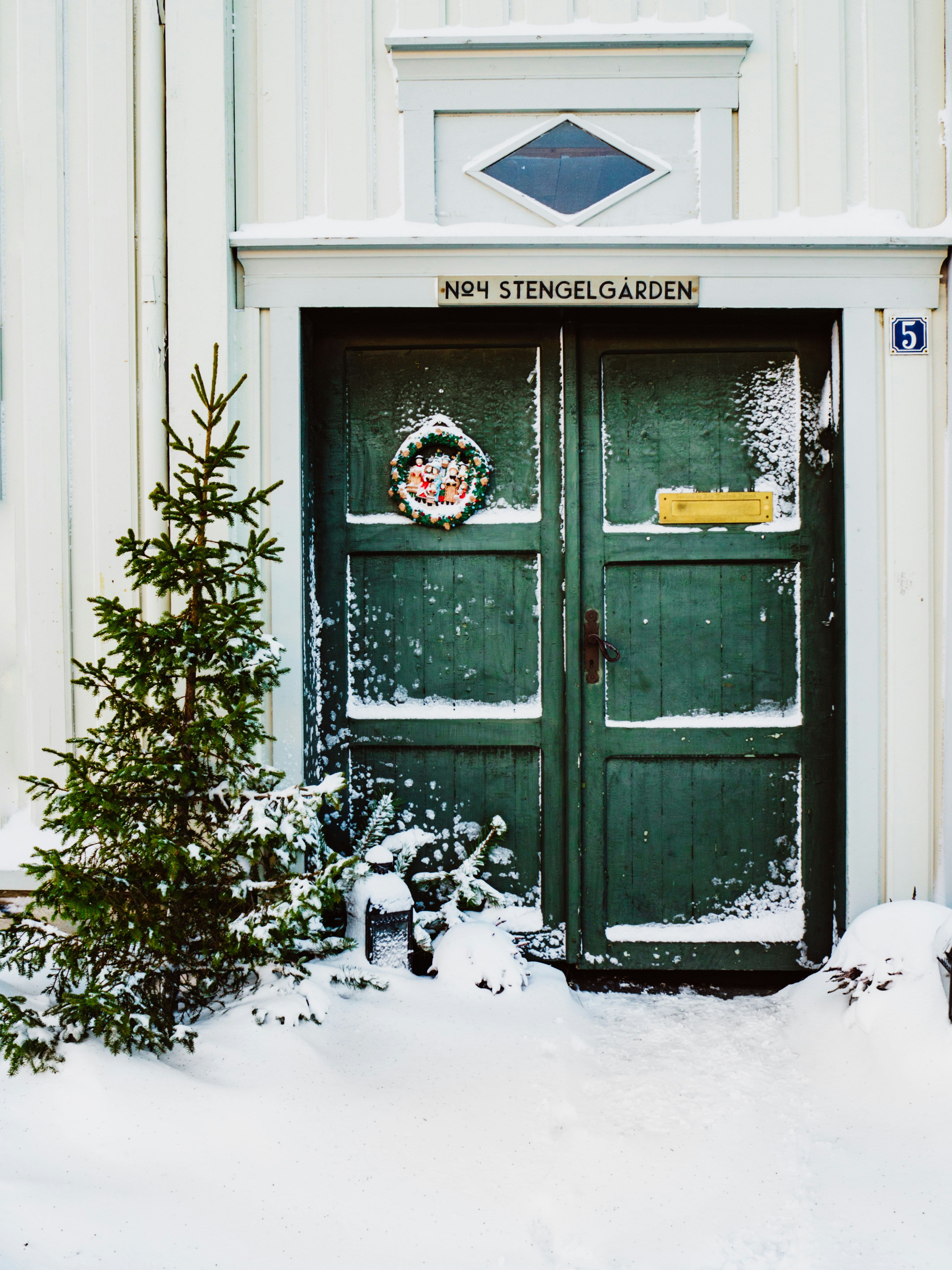 OLYMPUS DIGITAL CAMERA | Green doors decorated for christmas in the snow