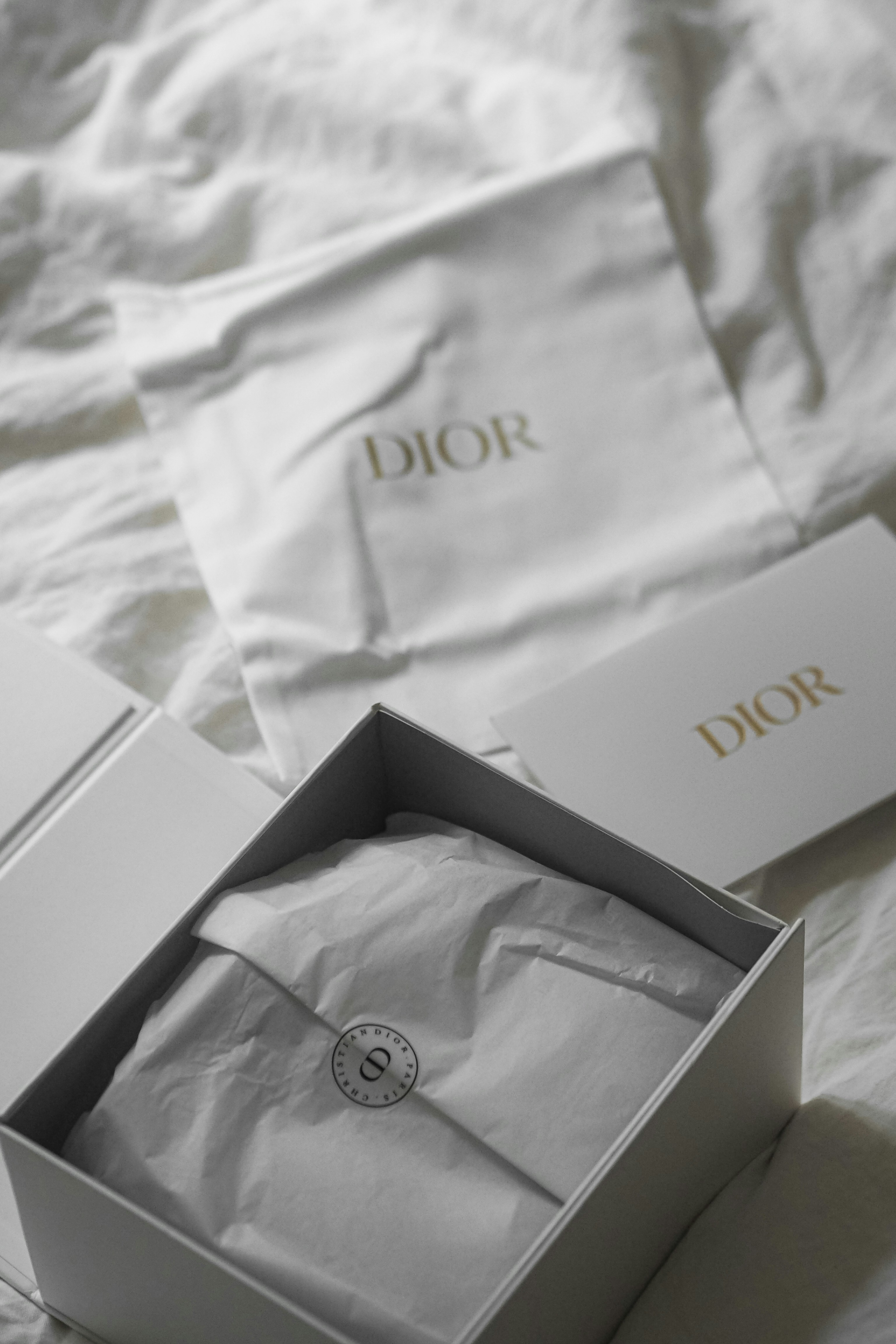 Dior gift box with branded packaging on white fabric photo – Free Style ...