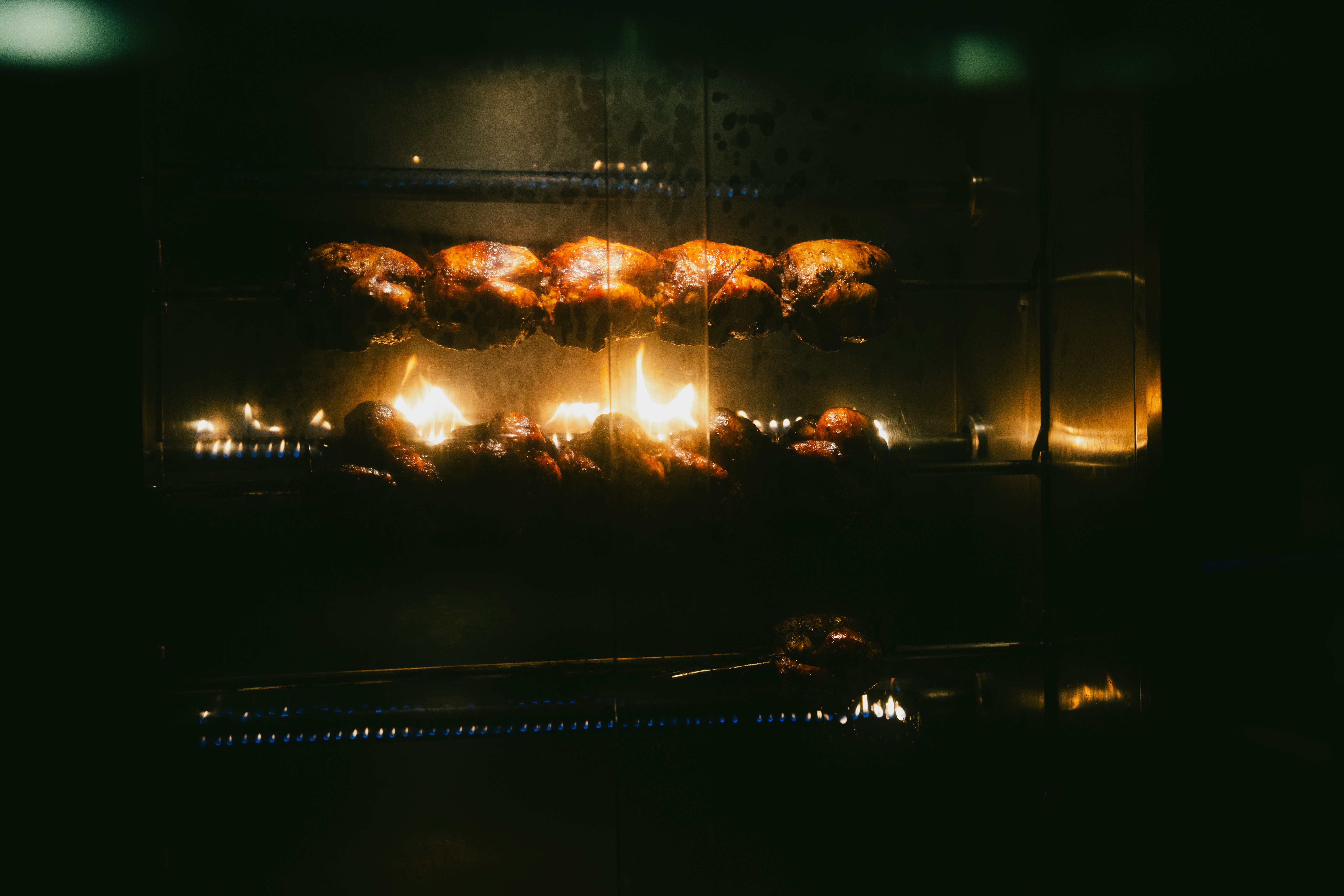 Chickens rotating on a rotisserie over flames photo – Free Food Image ...