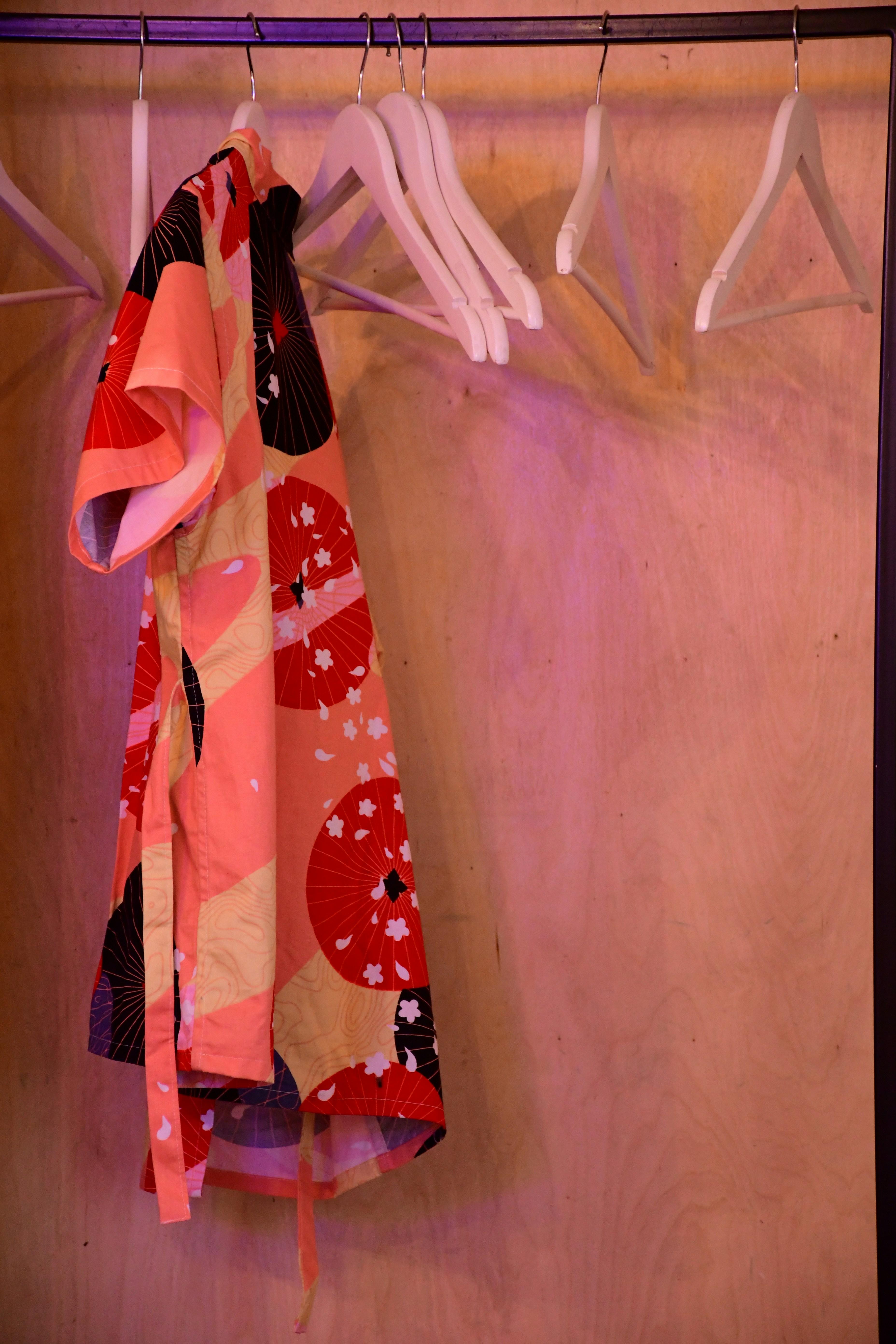 A patterned robe hangs on a clothing rack. photo – Free Fashion Image ...