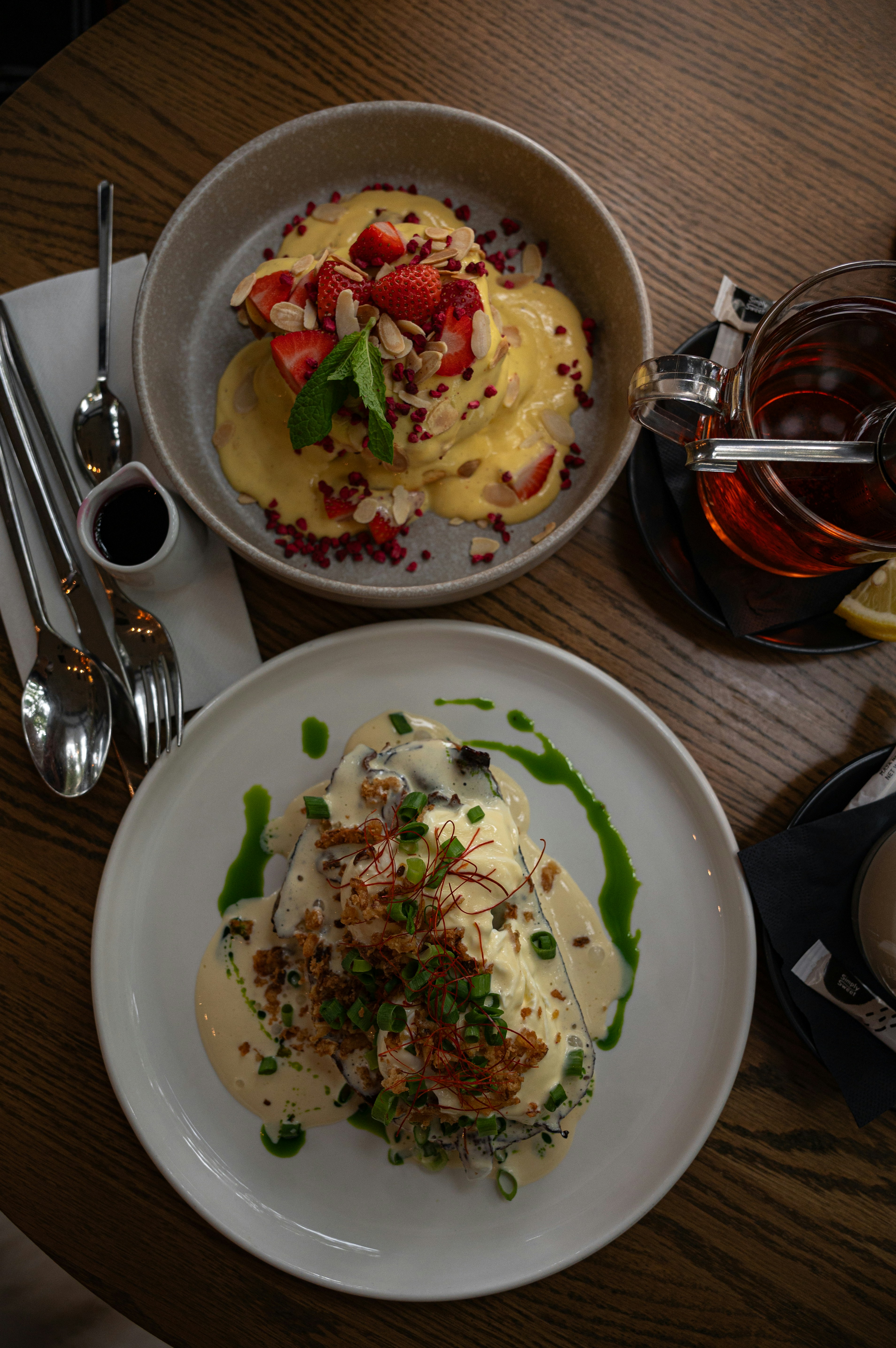 Two plates of food and a cup of tea.