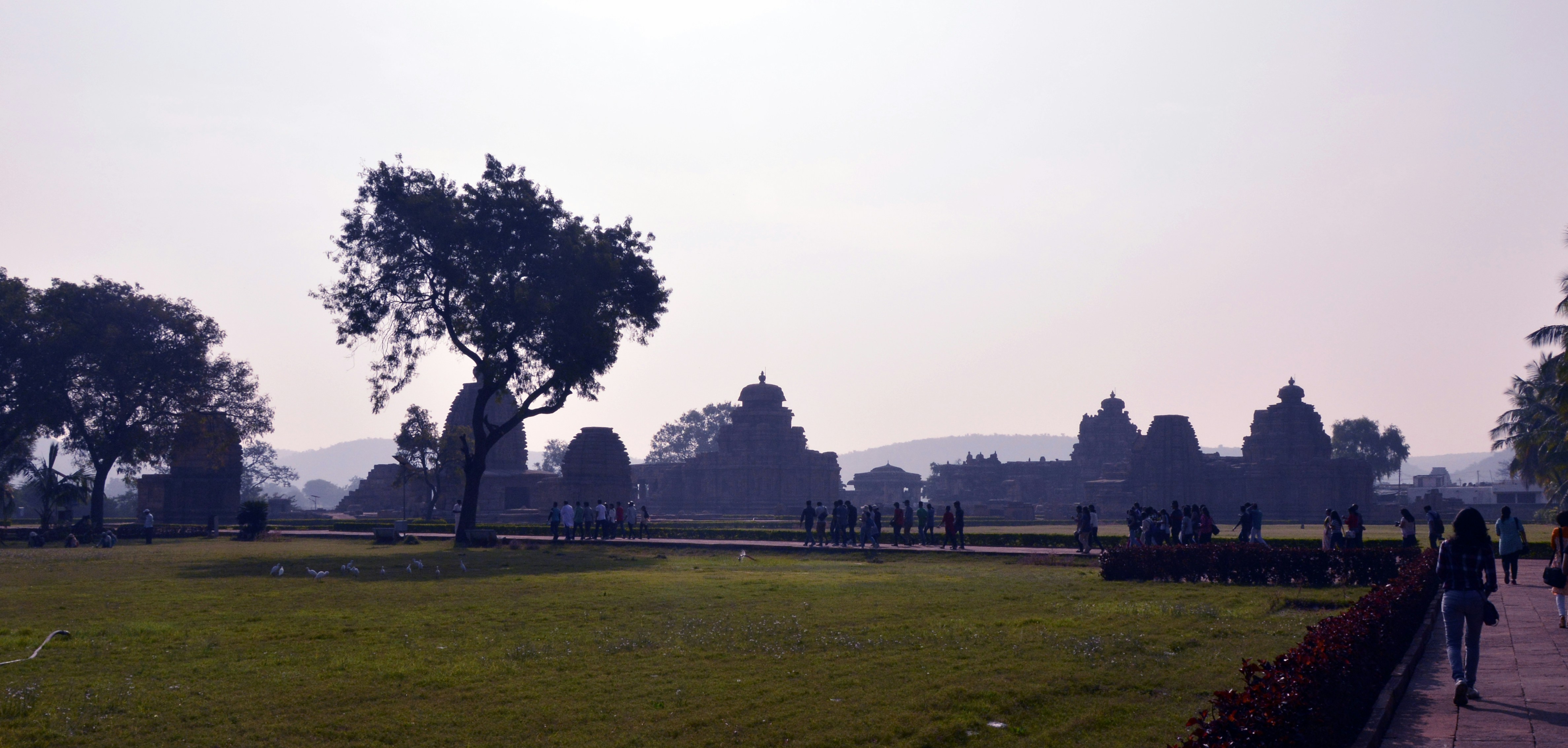 Silhouetted temple structures against a hazy sky